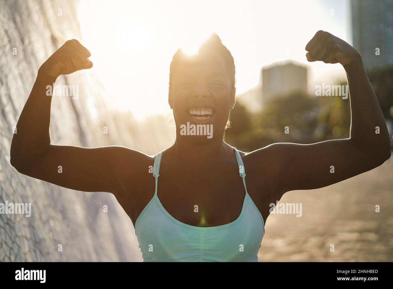 Happy african woman doing workout routine outdoor in the city - Focus ...