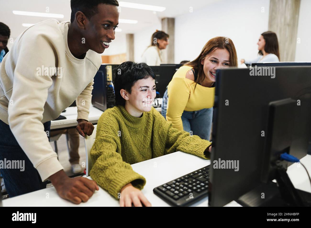 Young students using computers inside technology class at school room ...
