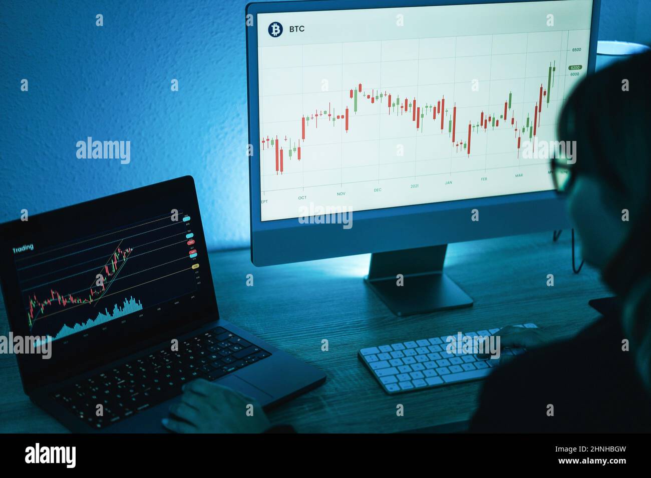 Trader woman studying stock market at home - Focus on right monitor ...
