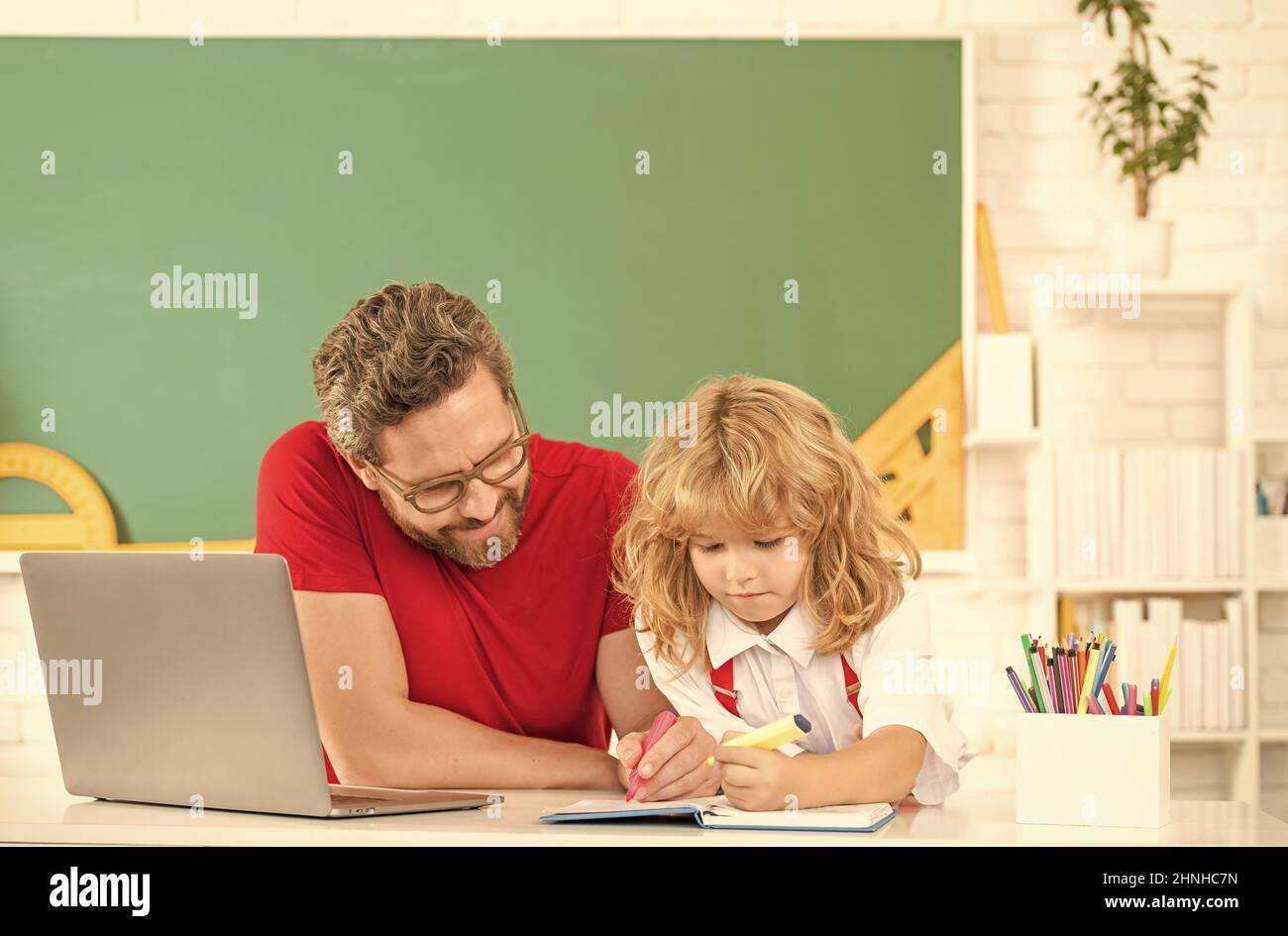 teacher man and kid study in classroom with laptop, fatherhood Stock ...