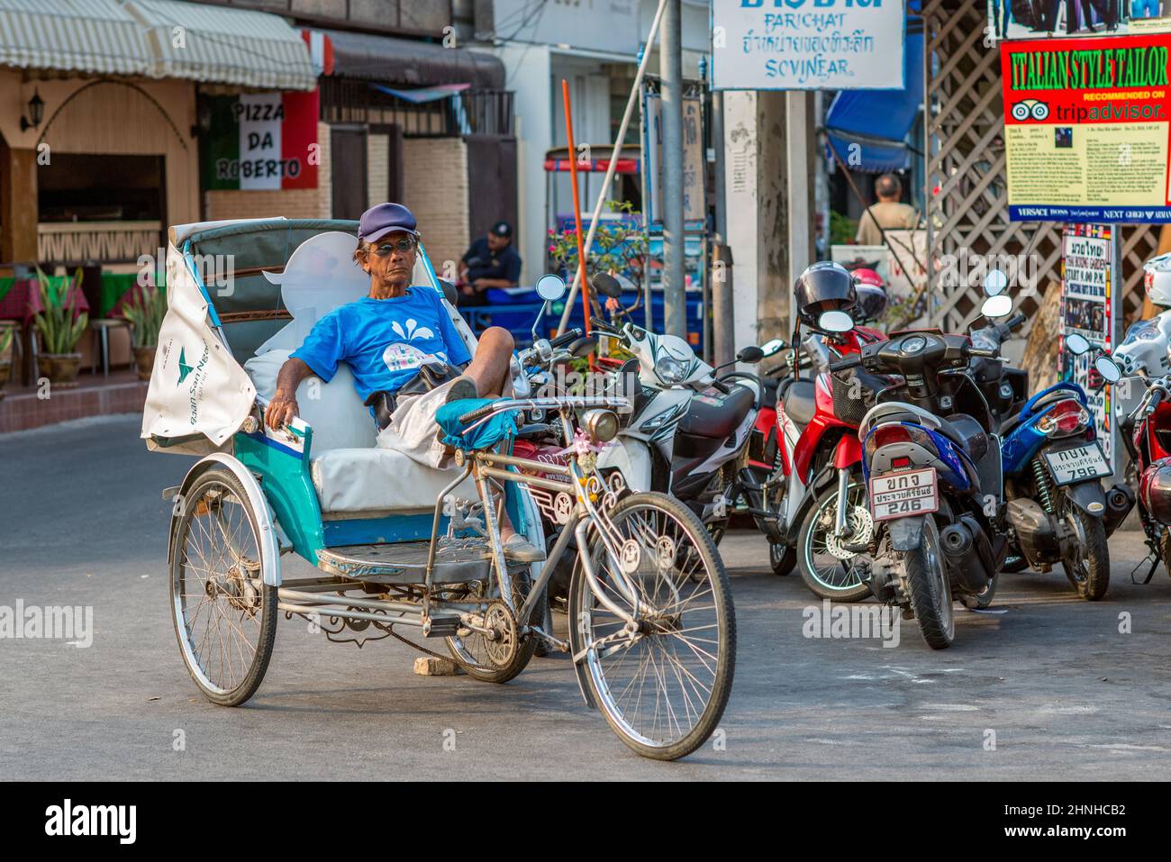 Rickshaw driver taking a break in Hua Hin. This is an old fishing ...