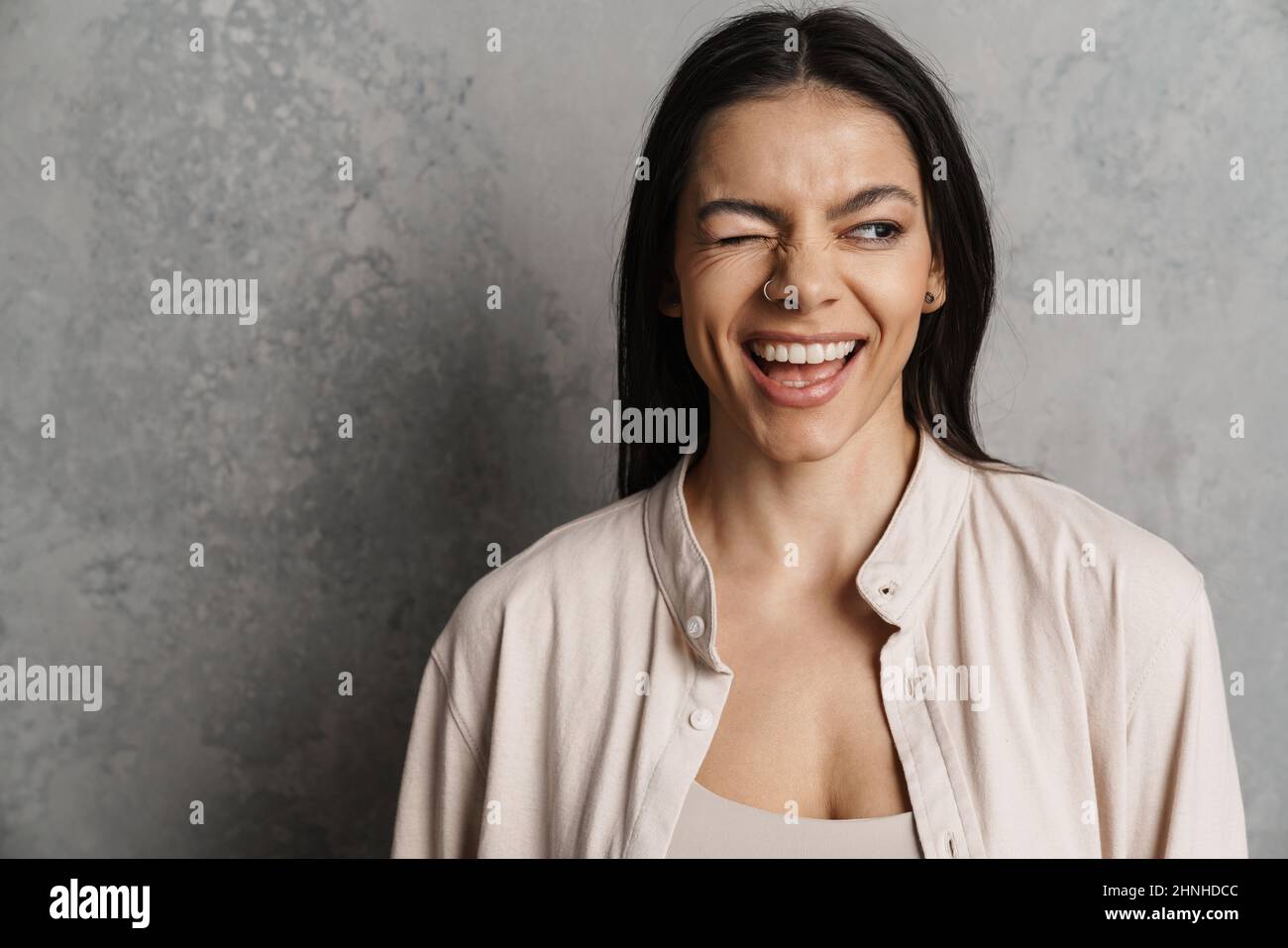 Winking young brunette woman hi-res stock photography and images - Alamy