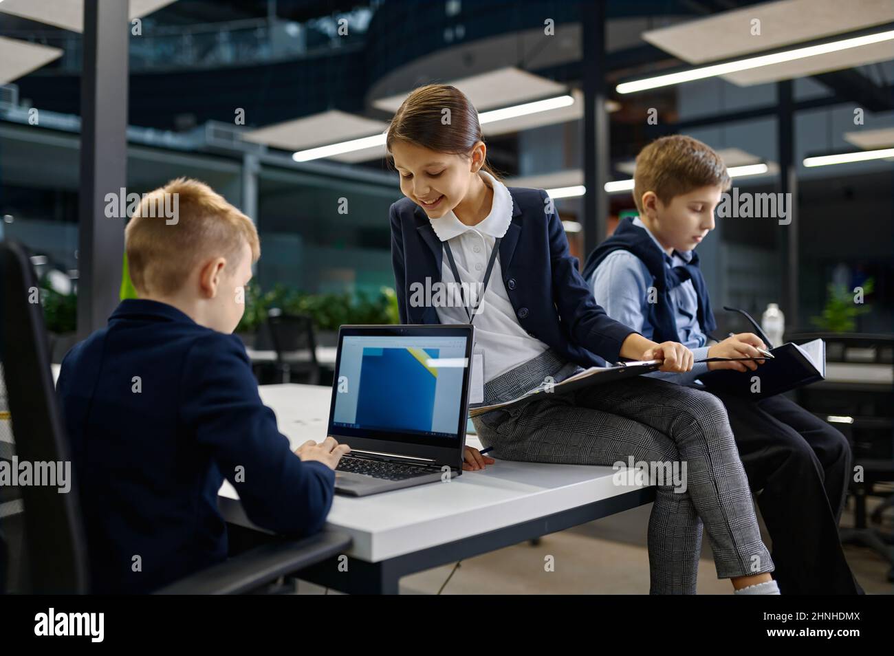 Boy and girl working together as team Stock Photo - Alamy