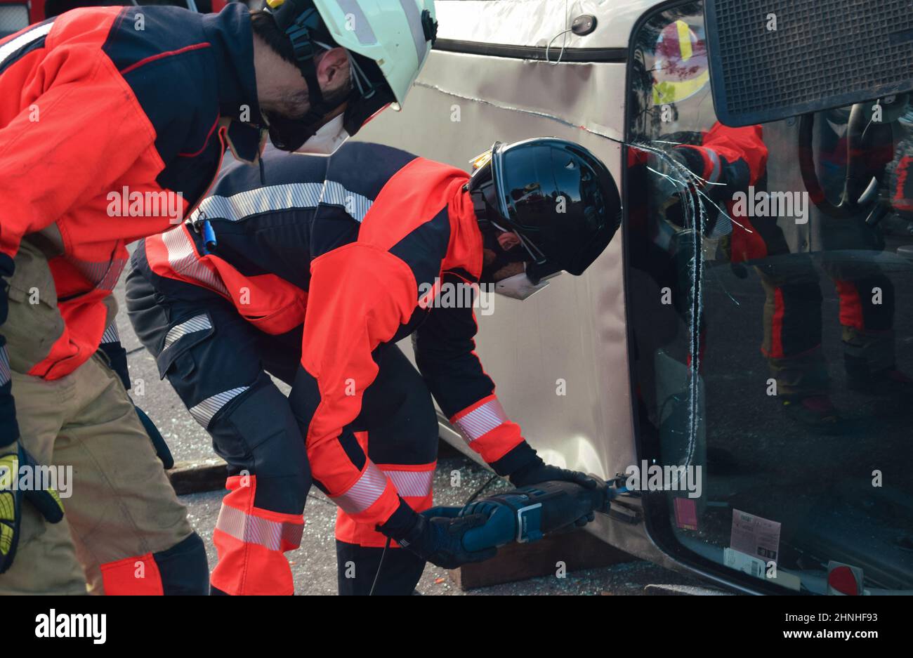 Firefighters rescuing a victim in a car accident Stock Photo - Alamy