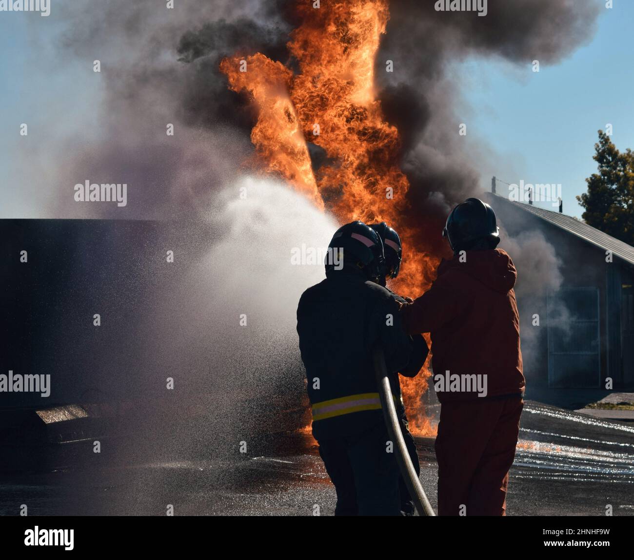 Firefighter extinguishing traffic fire Stock Photo - Alamy