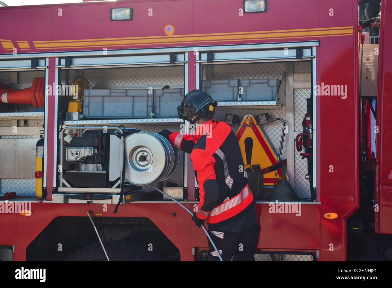 Firefighter exiting the fire truck before putting out a fire Stock ...