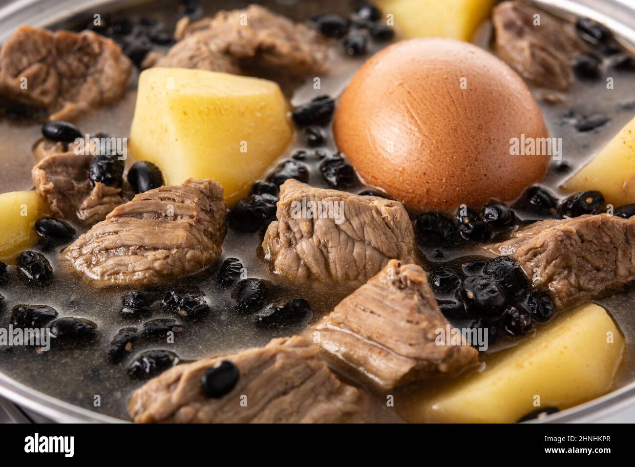 Traditional Jewish cholent on wooden table Stock Photo - Alamy