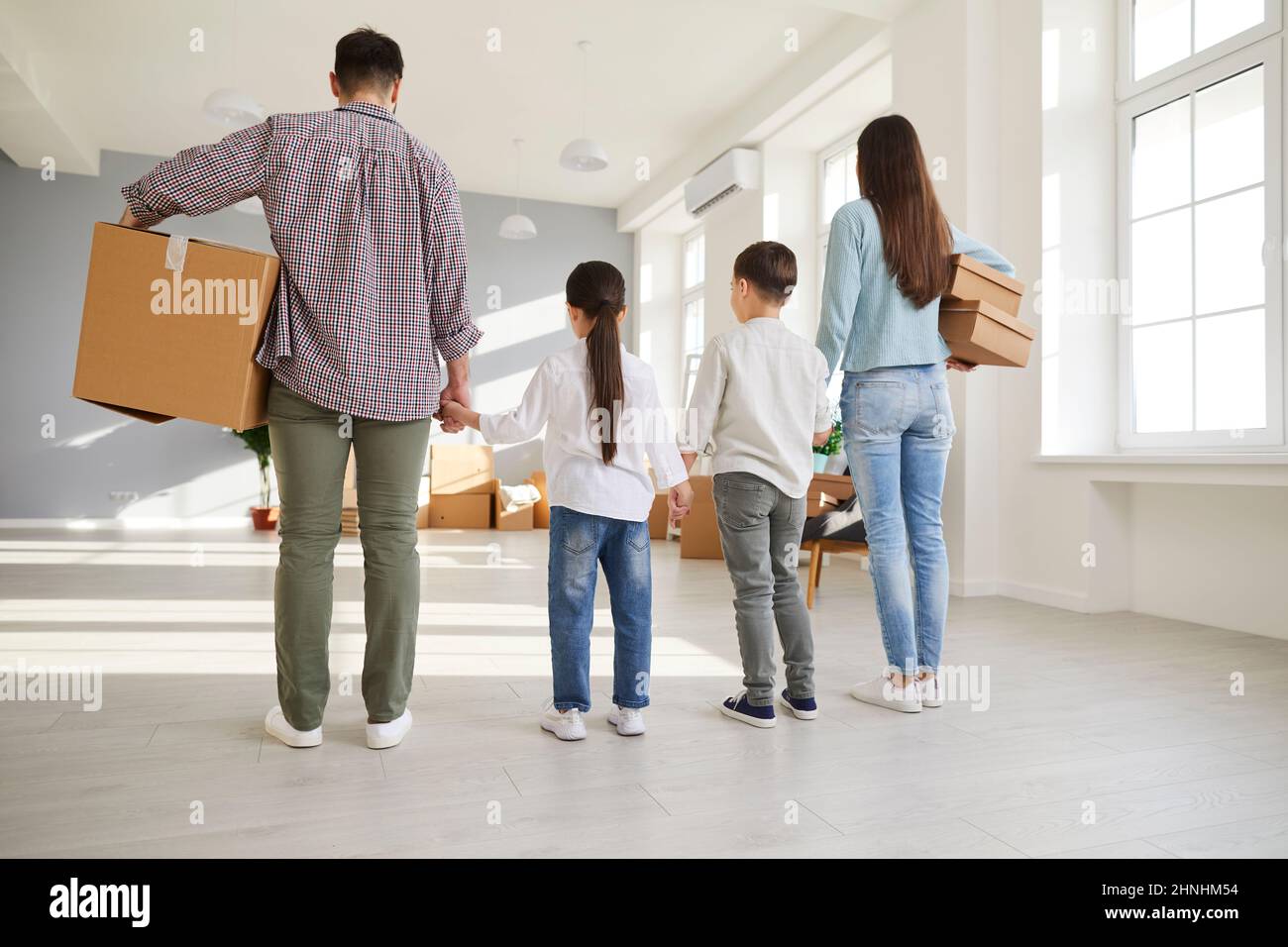 Young family with kids relocate with boxes to new house Stock Photo - Alamy