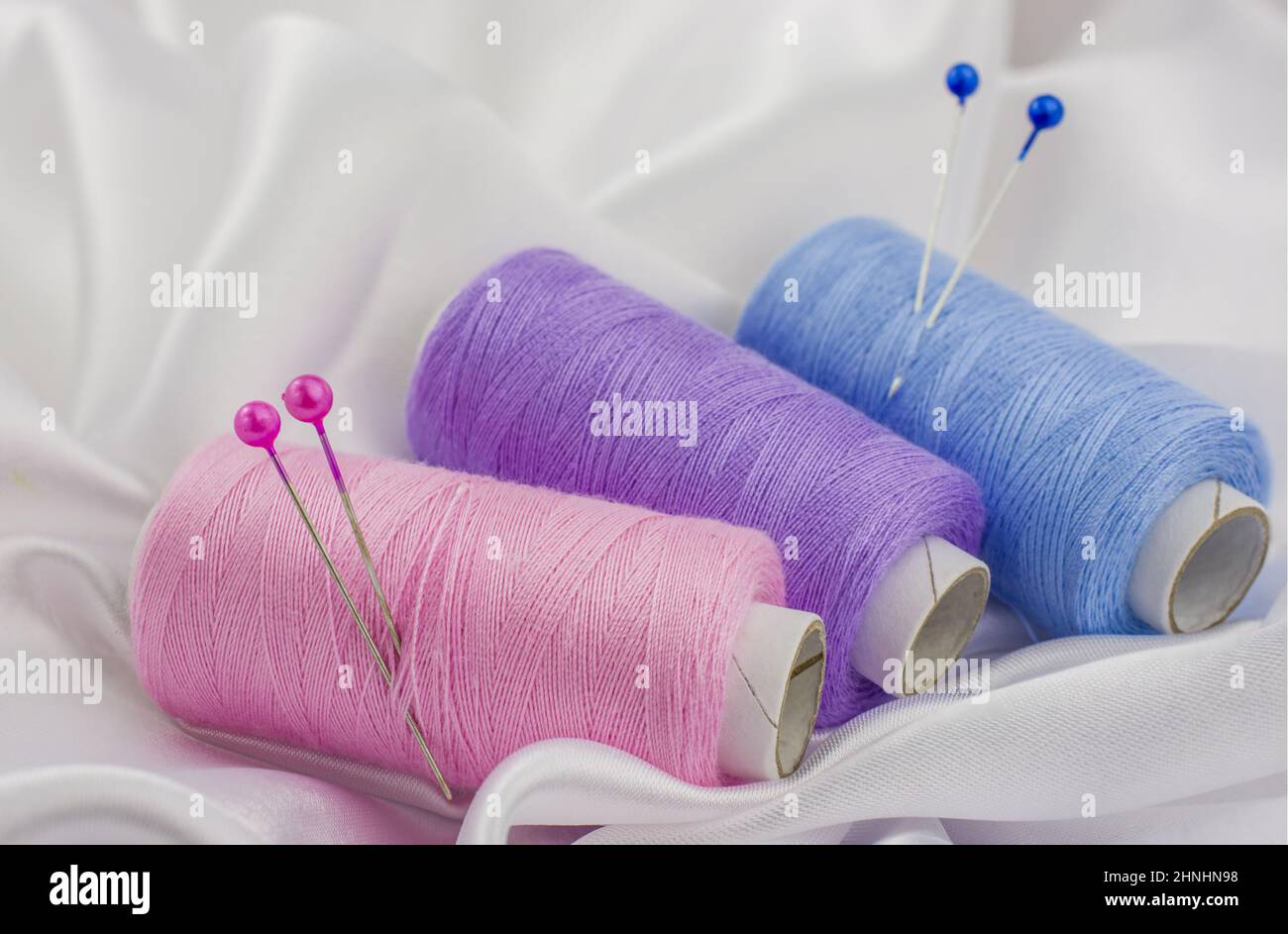 set of colouring threads on colourful background Stock Photo - Alamy