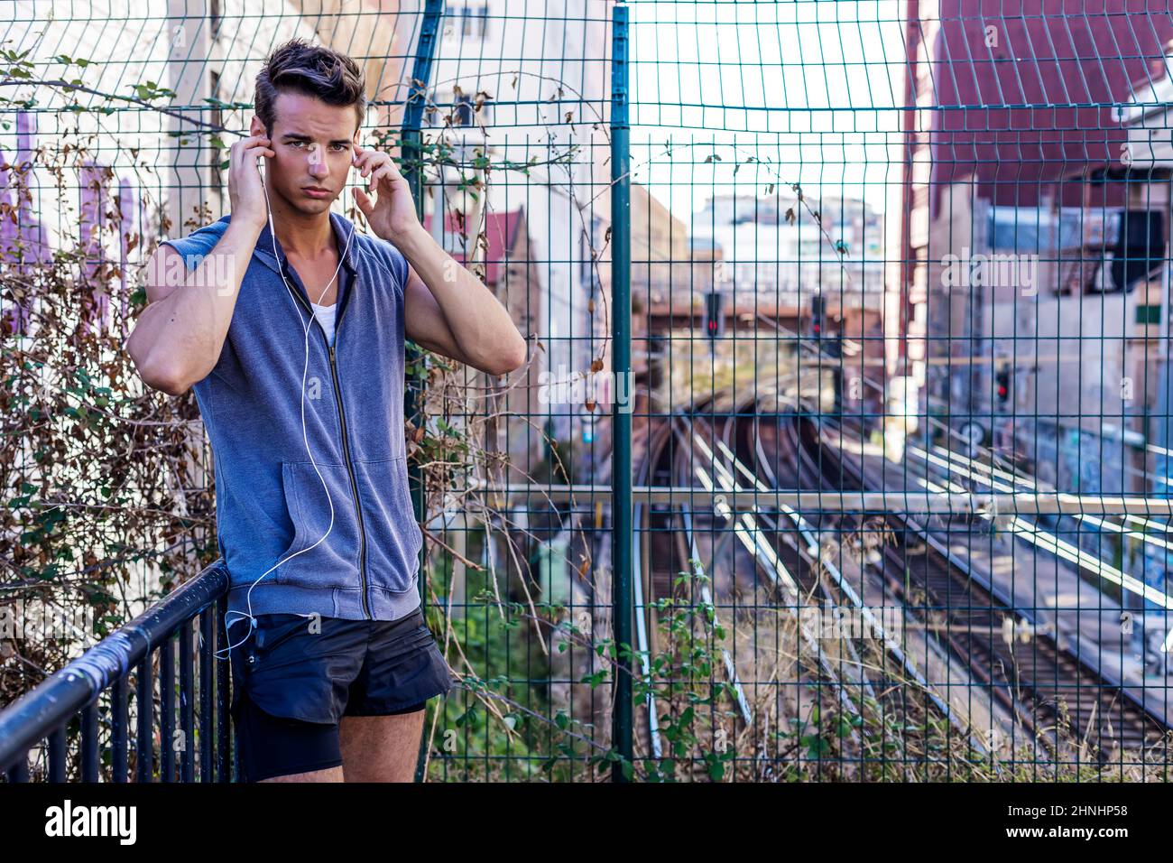 Shot of muscular young man relaxing after workout. Male runner man ...