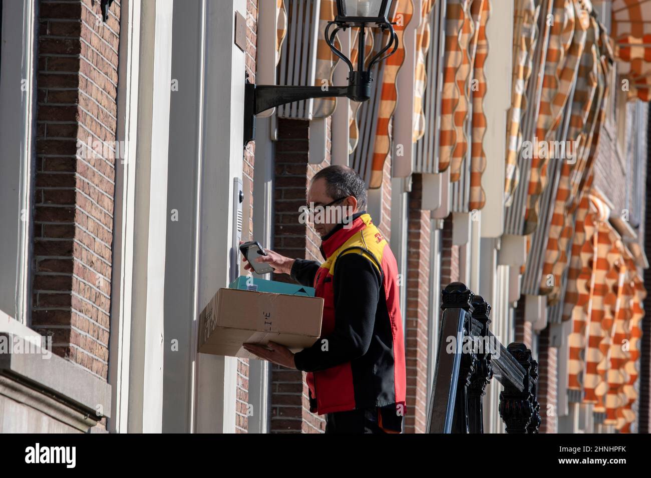 DHL Delivery Man At Work At Amsterdam The Netherlands 8-2-2022 Stock ...