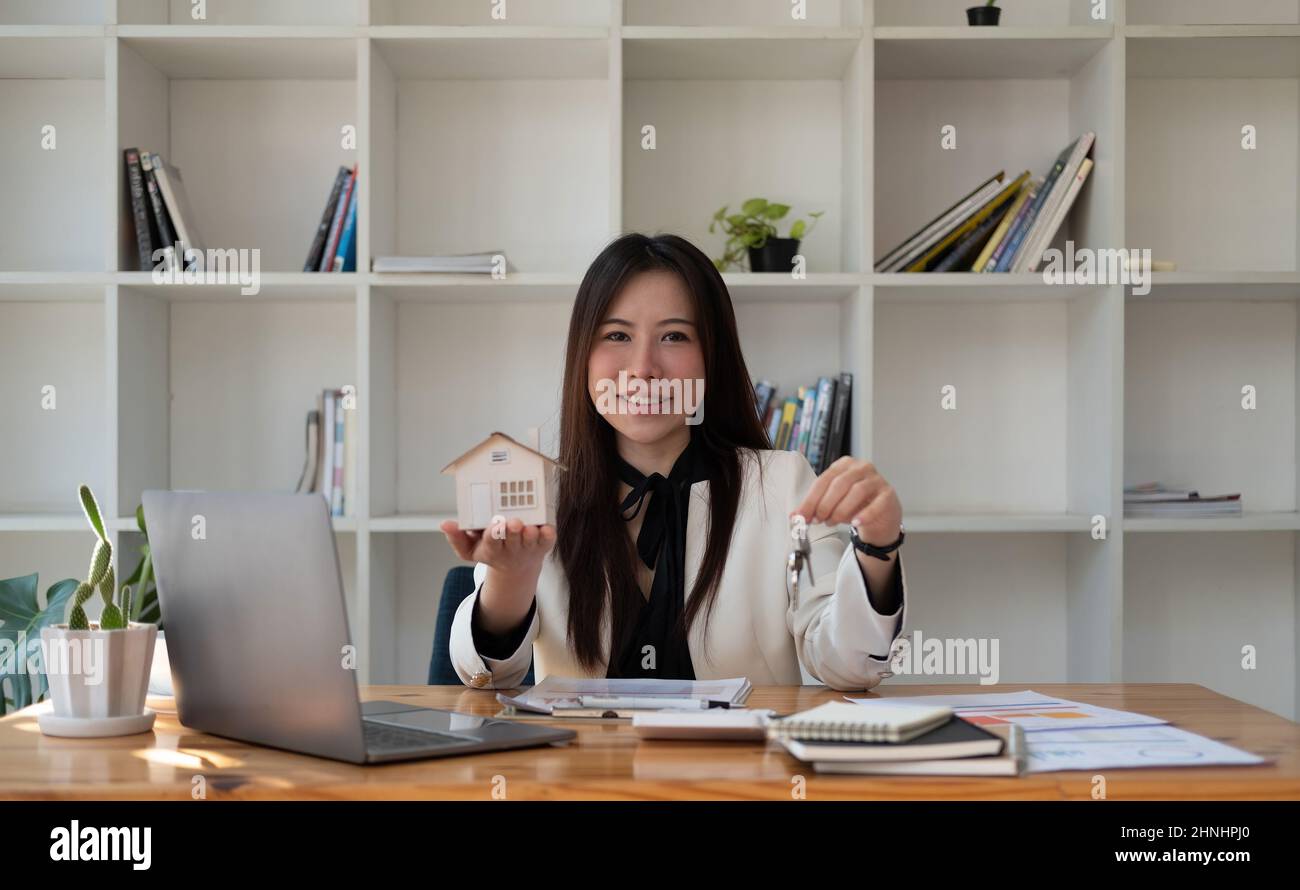 Portrait asian businesswoman real estate hand holding house model and ...