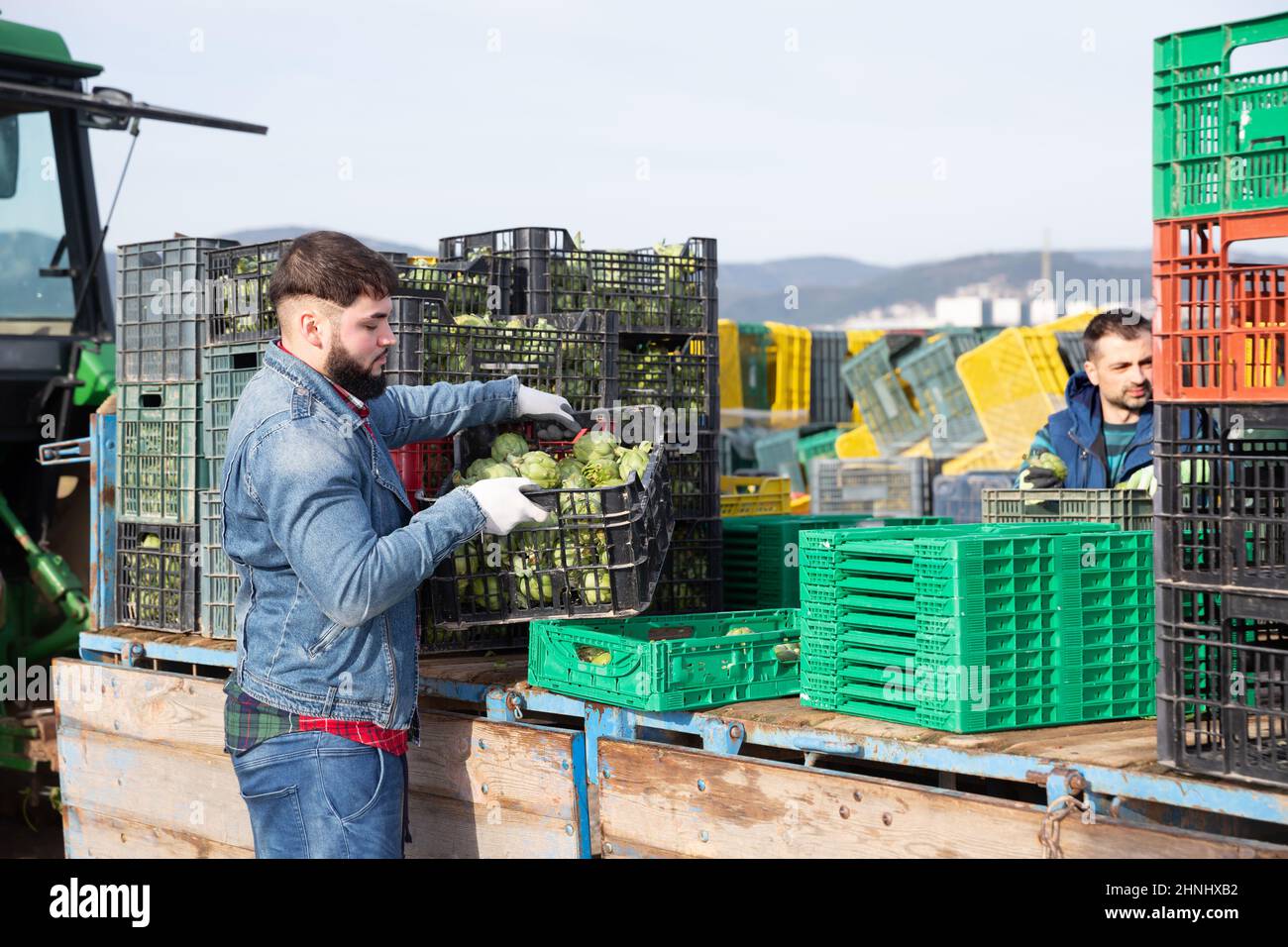 Worker stacking plastic crates hi-res stock photography and images - Alamy