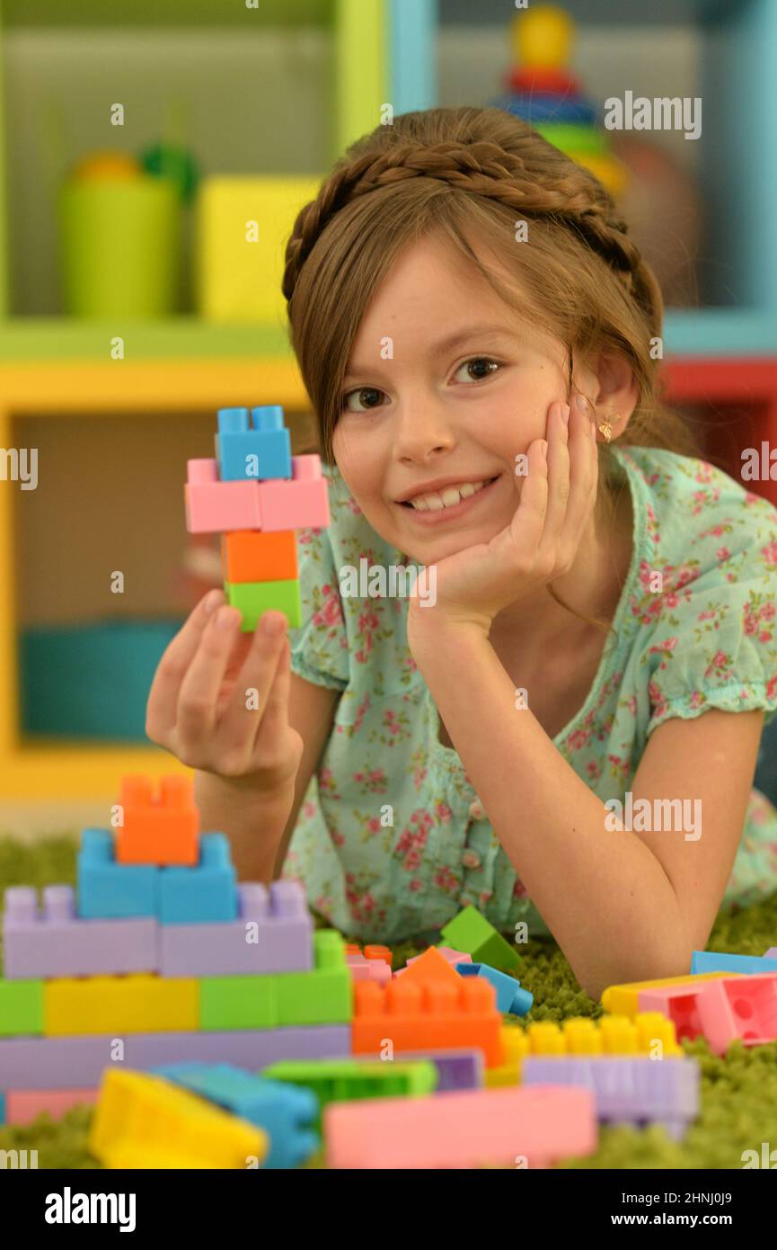 Happy cute little girl playing with cubes Stock Photo - Alamy