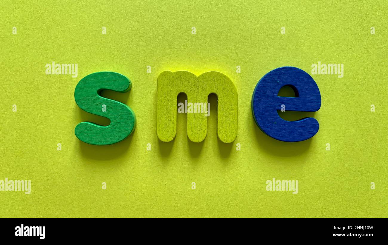 SME letters with yellow background desk cover. Business concept Stock ...