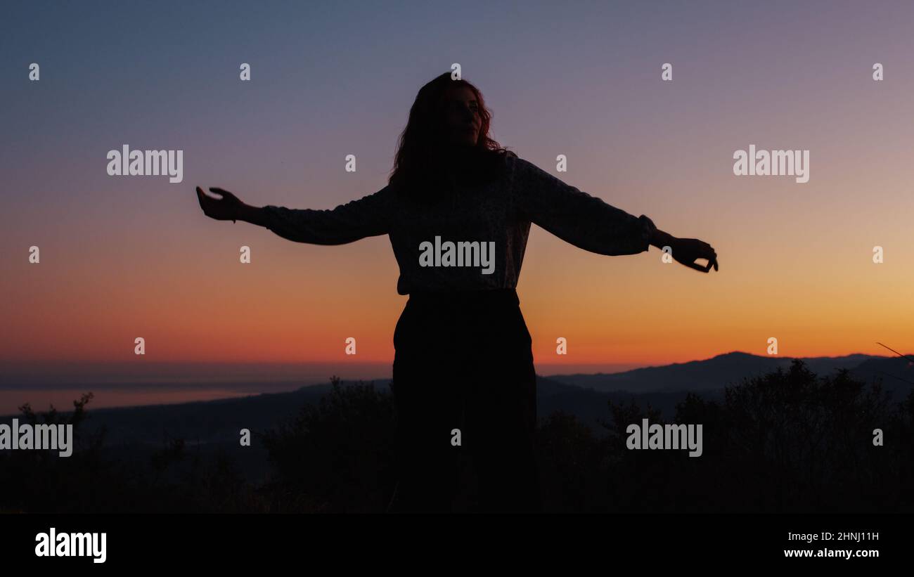 silhouette of carefree dancing girl at sunset Stock Photo - Alamy