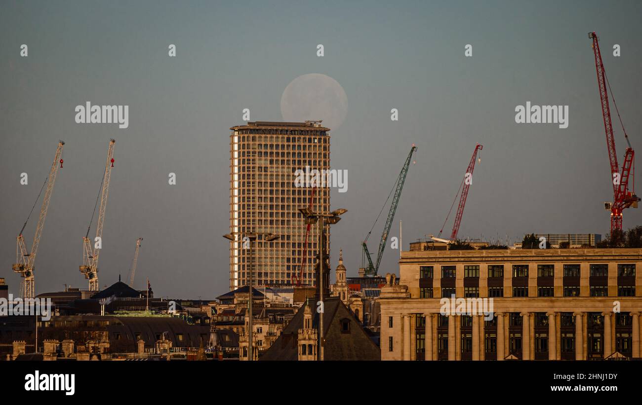 The february full moon known as the Snow Moon sets on Centre Point in ...