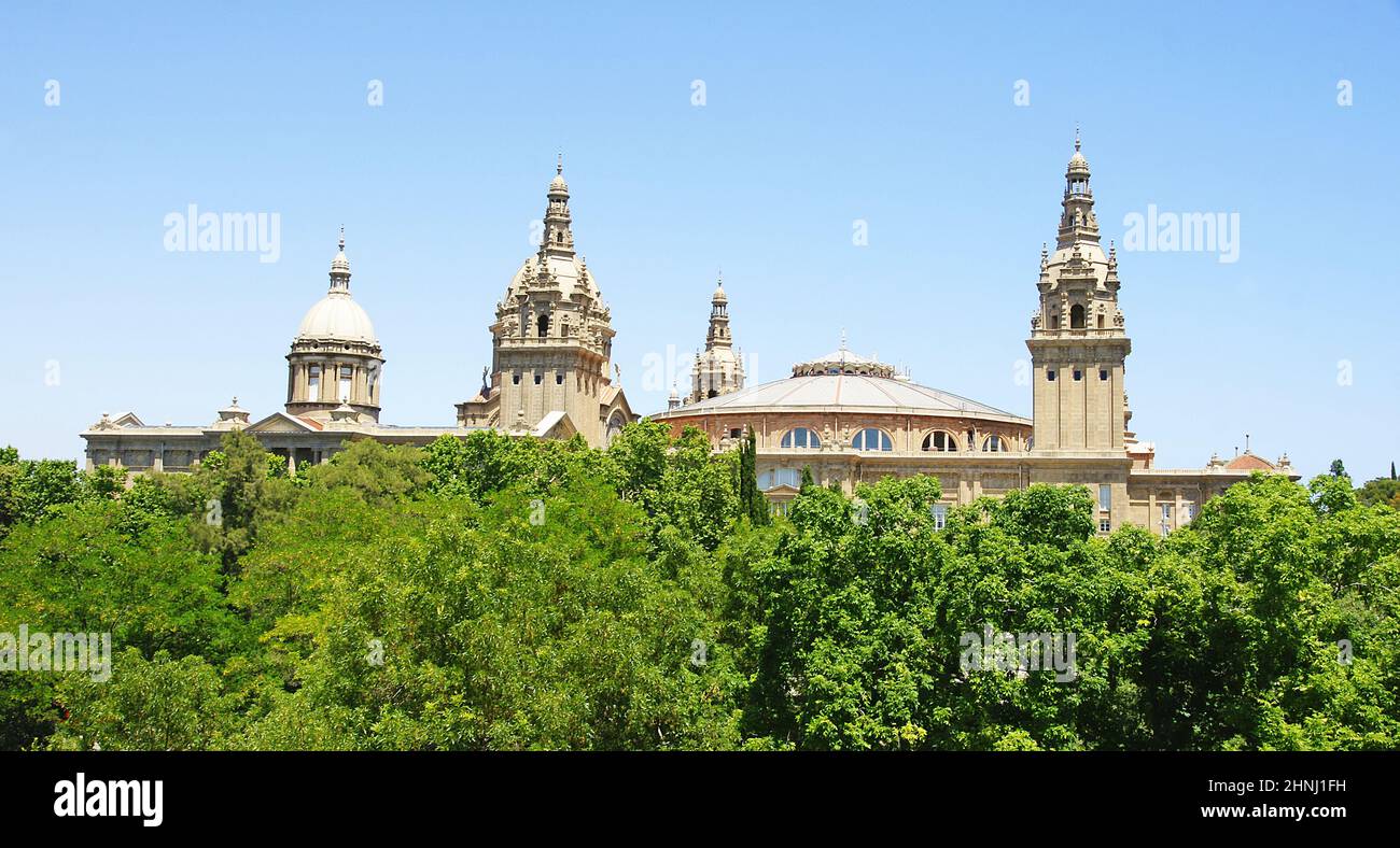 Flowerbed on the Montjuic mountain with the upper part of the domes of ...