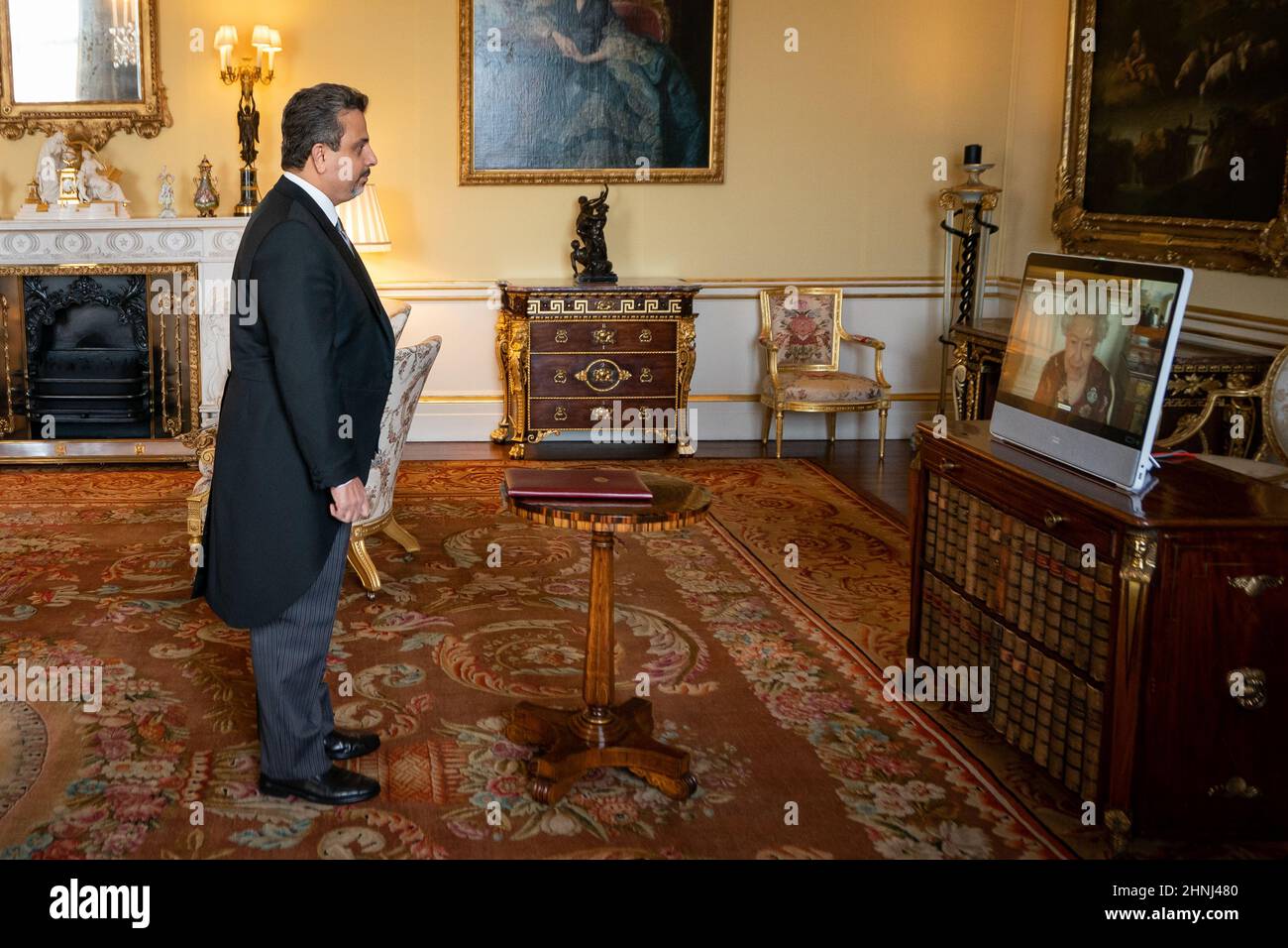 Queen Elizabeth II appears on a screen via videolink from Windsor ...