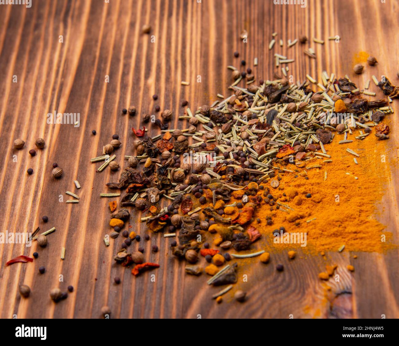 Dried different spices on wooden texture background Stock Photo - Alamy