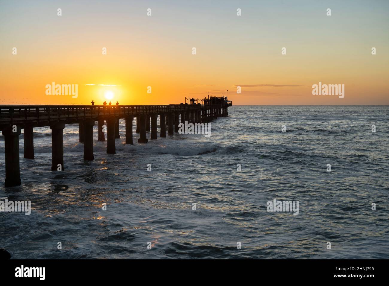 Old long wooden jetty at sunset Stock Photo - Alamy
