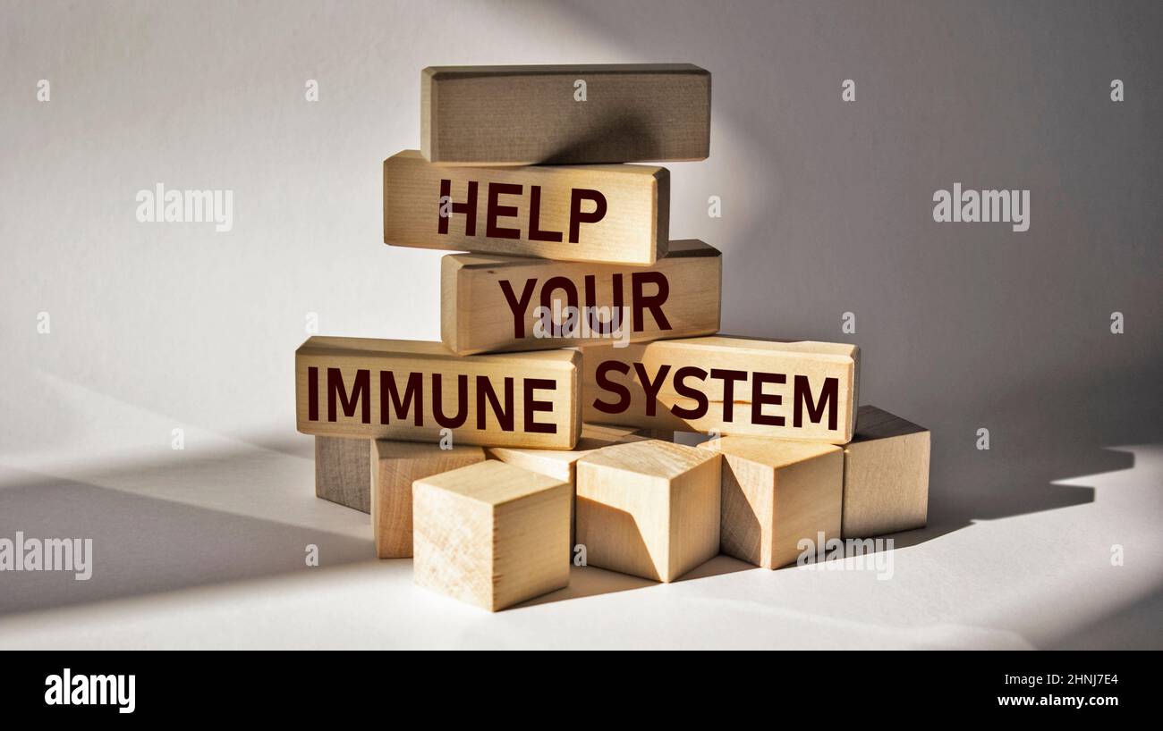 HELP YOUR IMMUNE SYSTEM written on wooden cubes on medical background ...