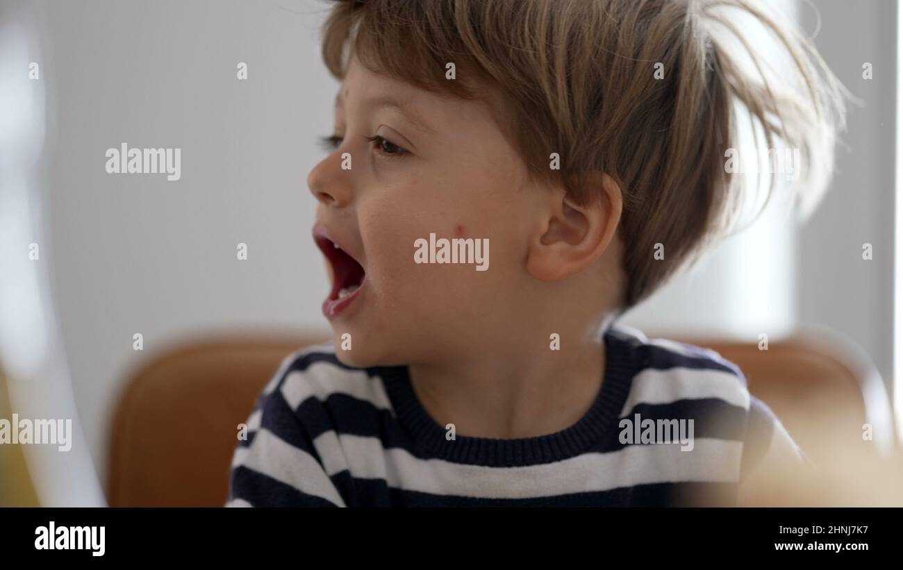 One child shakes head and hair being goofy and fun Stock Photo - Alamy