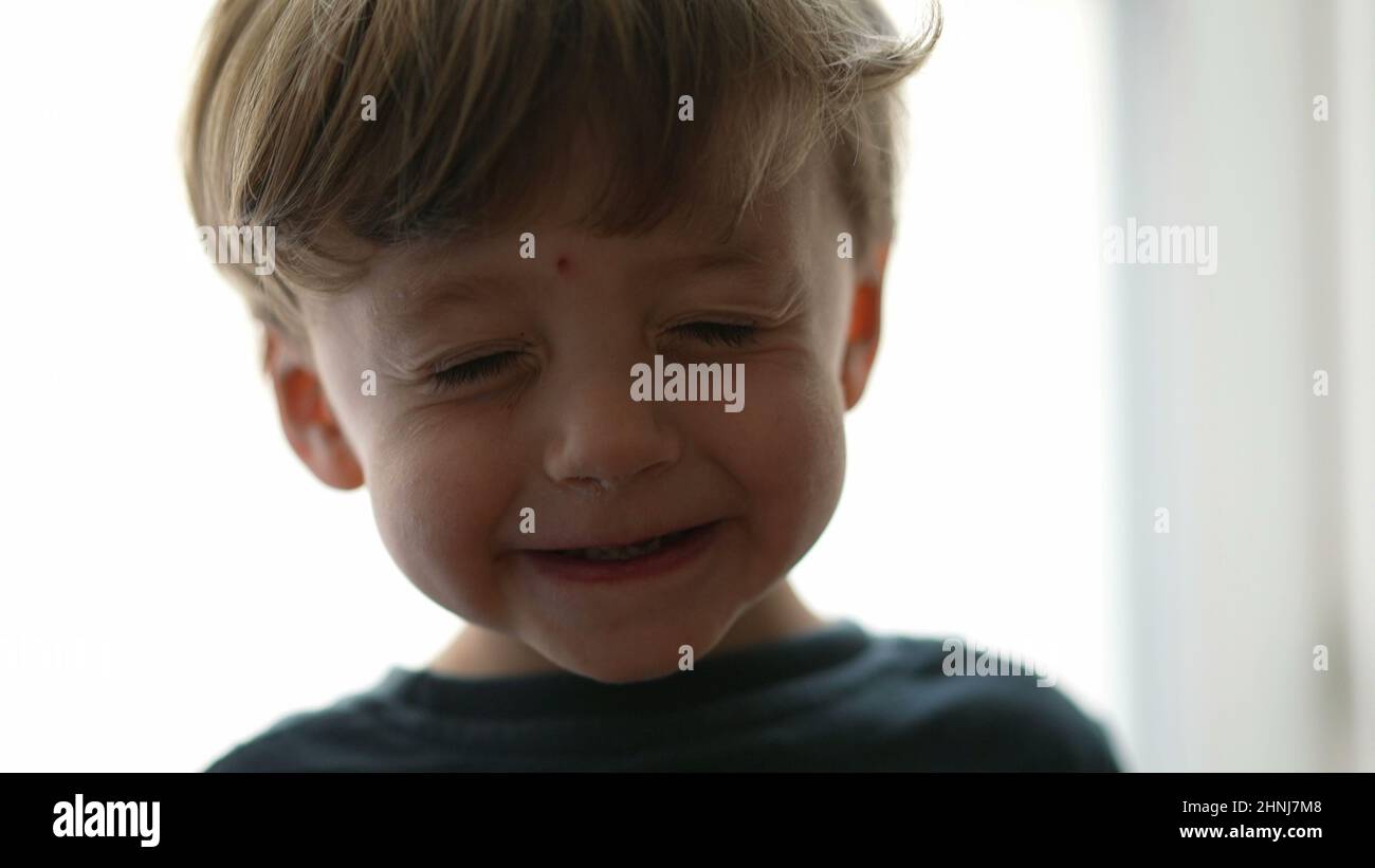 One cute goofy child eyes closed adorable kid opening eyes Stock Photo ...