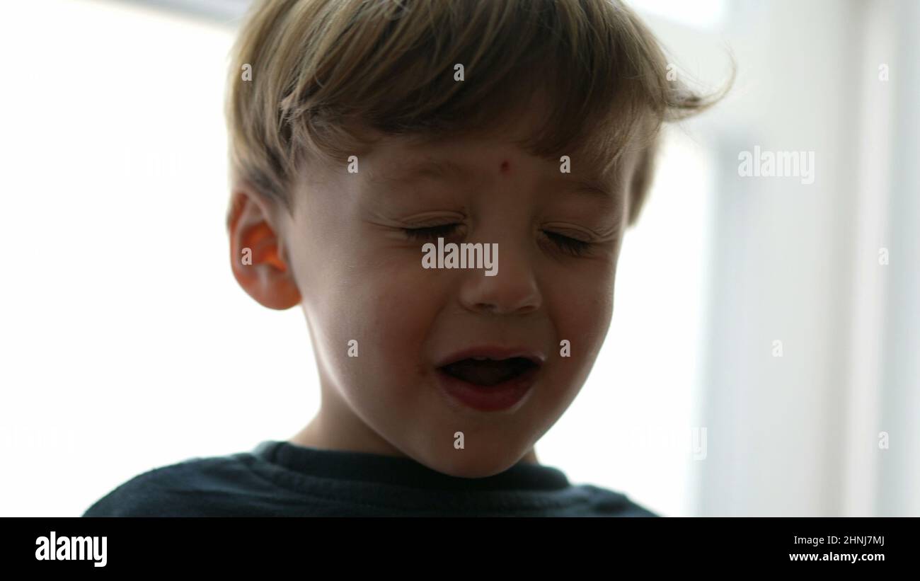 One Cute little boy closing eyes child eyes closed Stock Photo - Alamy