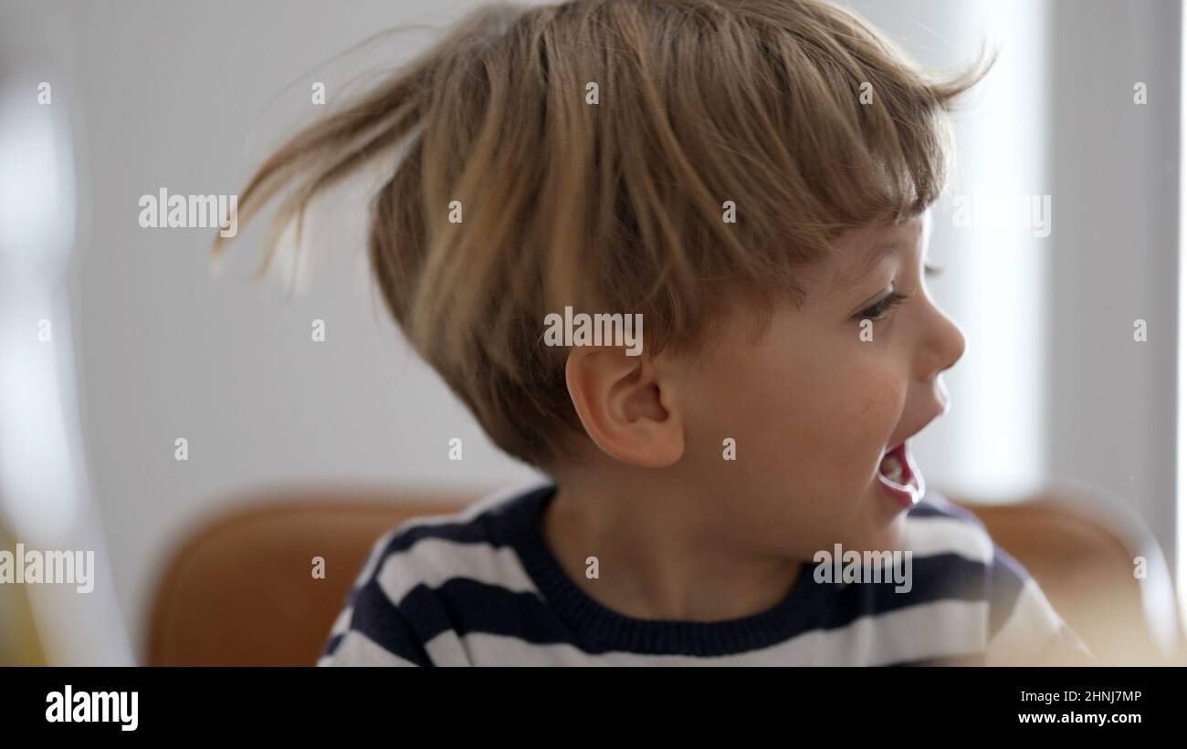 One child shakes head and hair being goofy and fun Stock Photo - Alamy