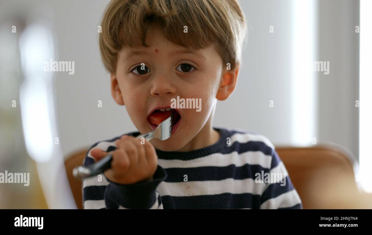 One little boy eating fruit snack with fruit Stock Photo - Alamy