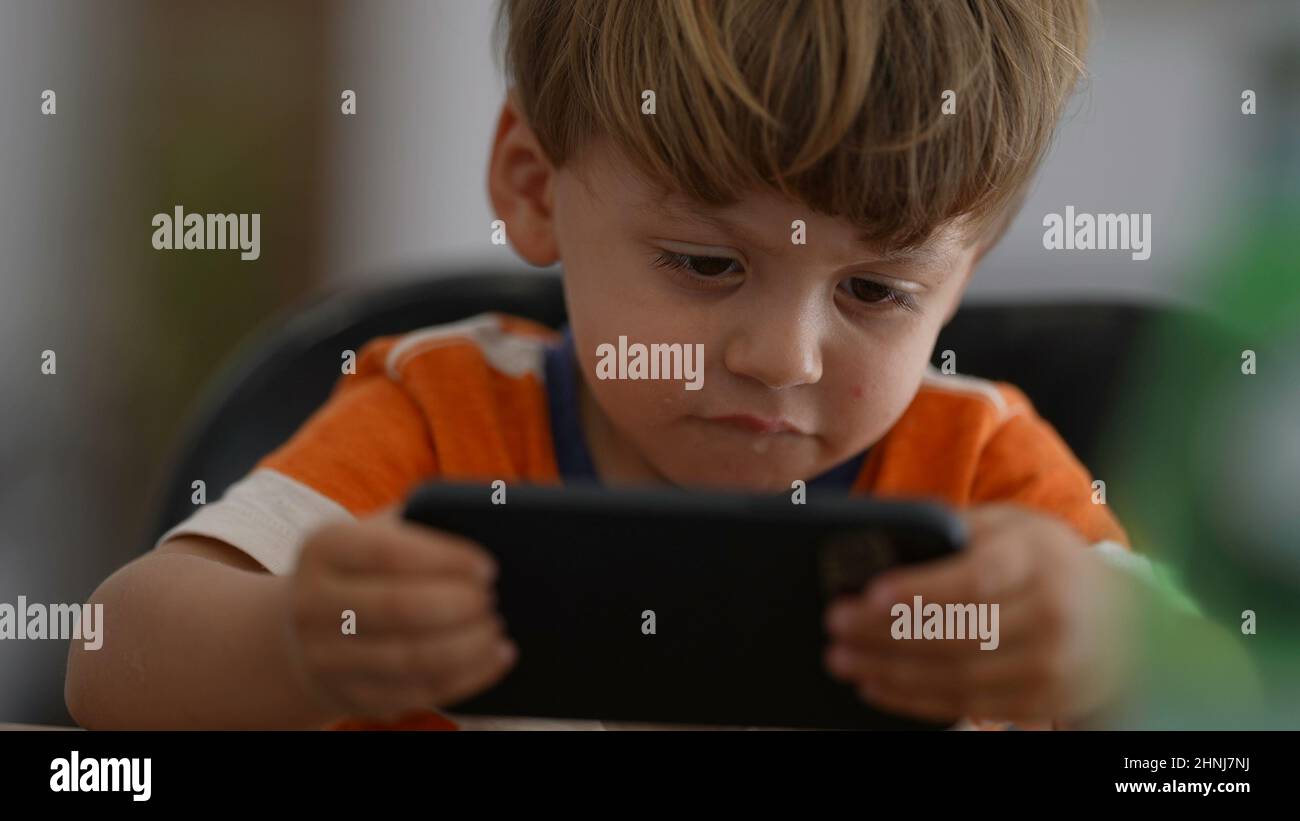 One kid using cellphone device child holding phone Stock Photo - Alamy