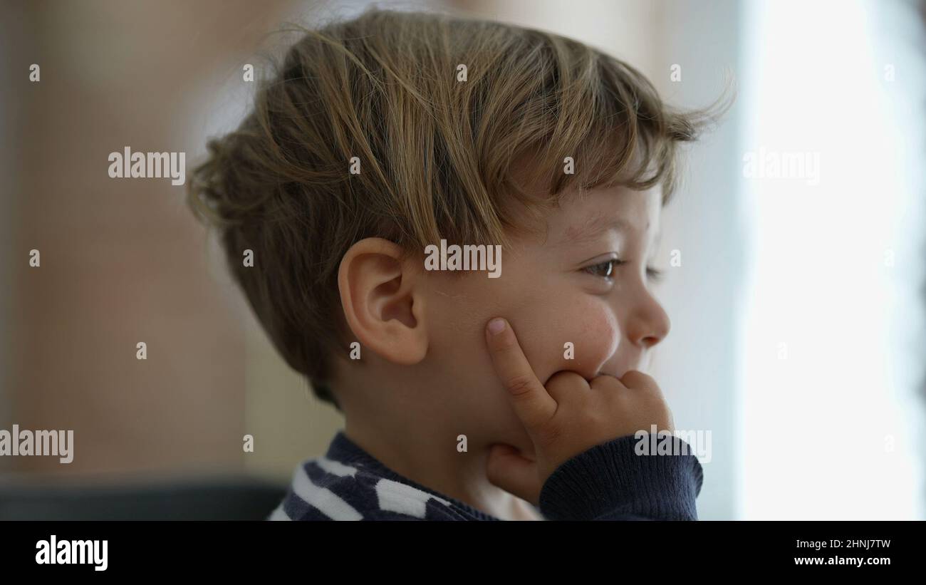 One pensive little boy thoughtful child portrait face Stock Photo - Alamy