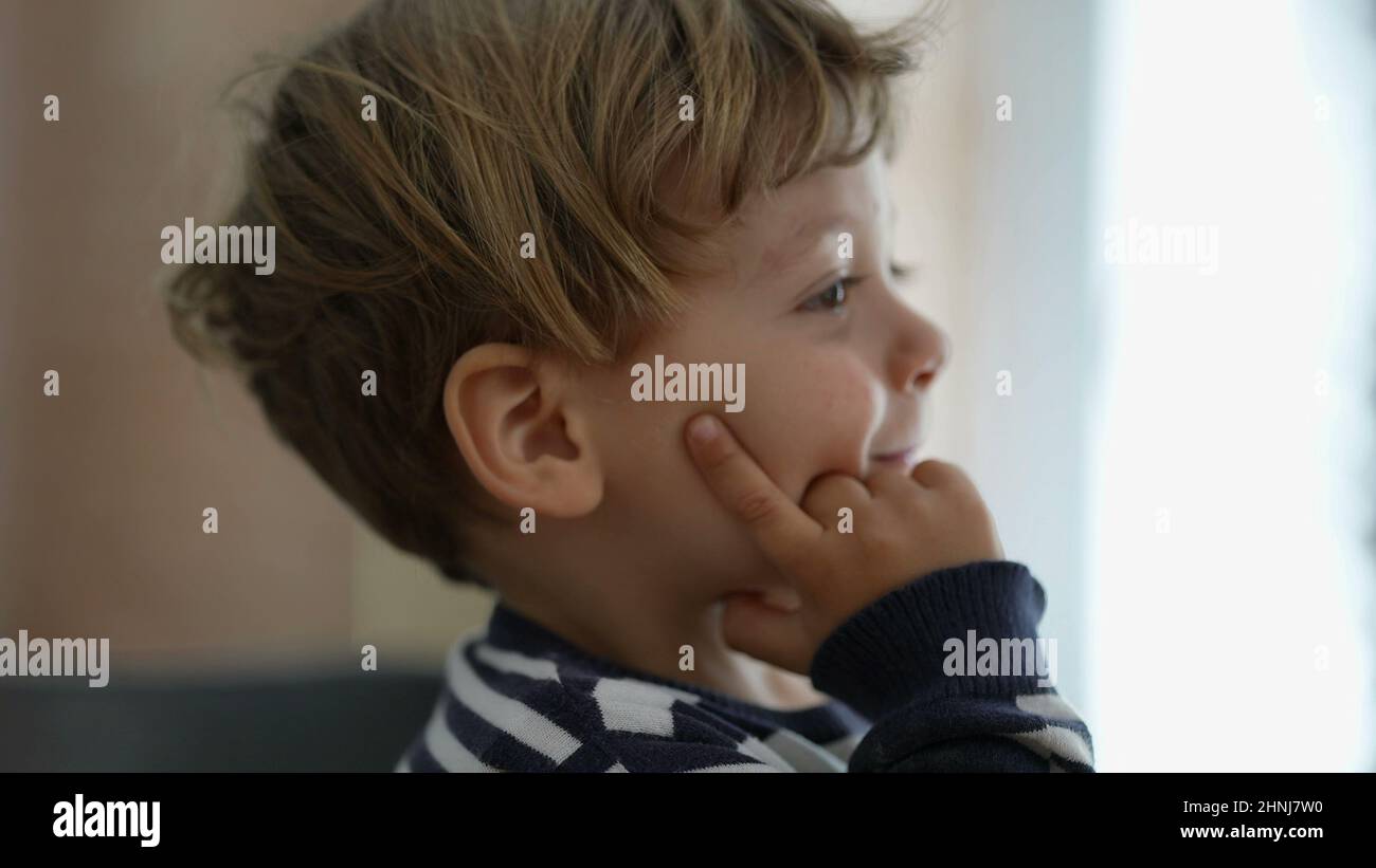 One pensive little boy thoughtful child portrait face Stock Photo - Alamy
