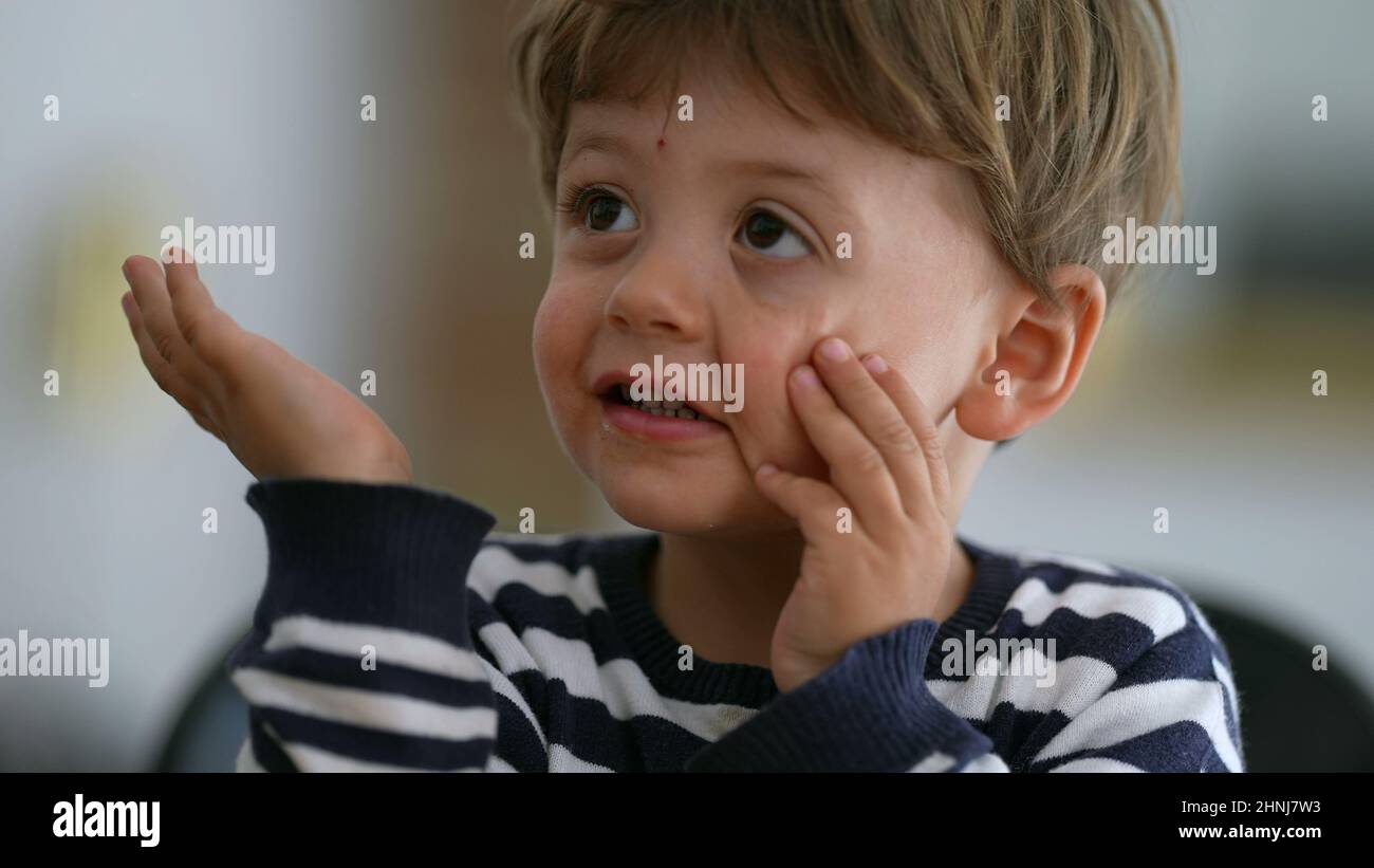 One pensive little boy thoughtful child portrait face Stock Photo - Alamy