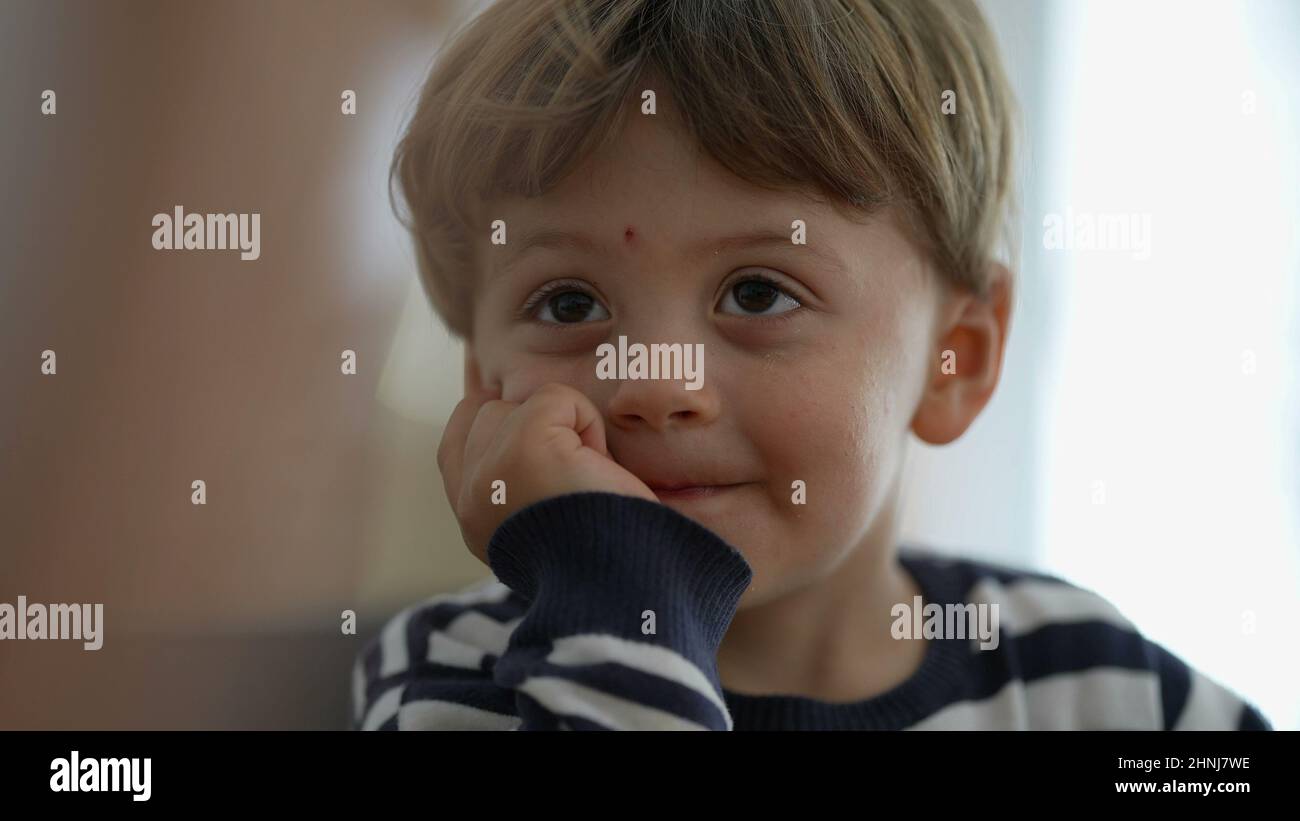 One pensive little boy thoughtful child portrait face Stock Photo - Alamy