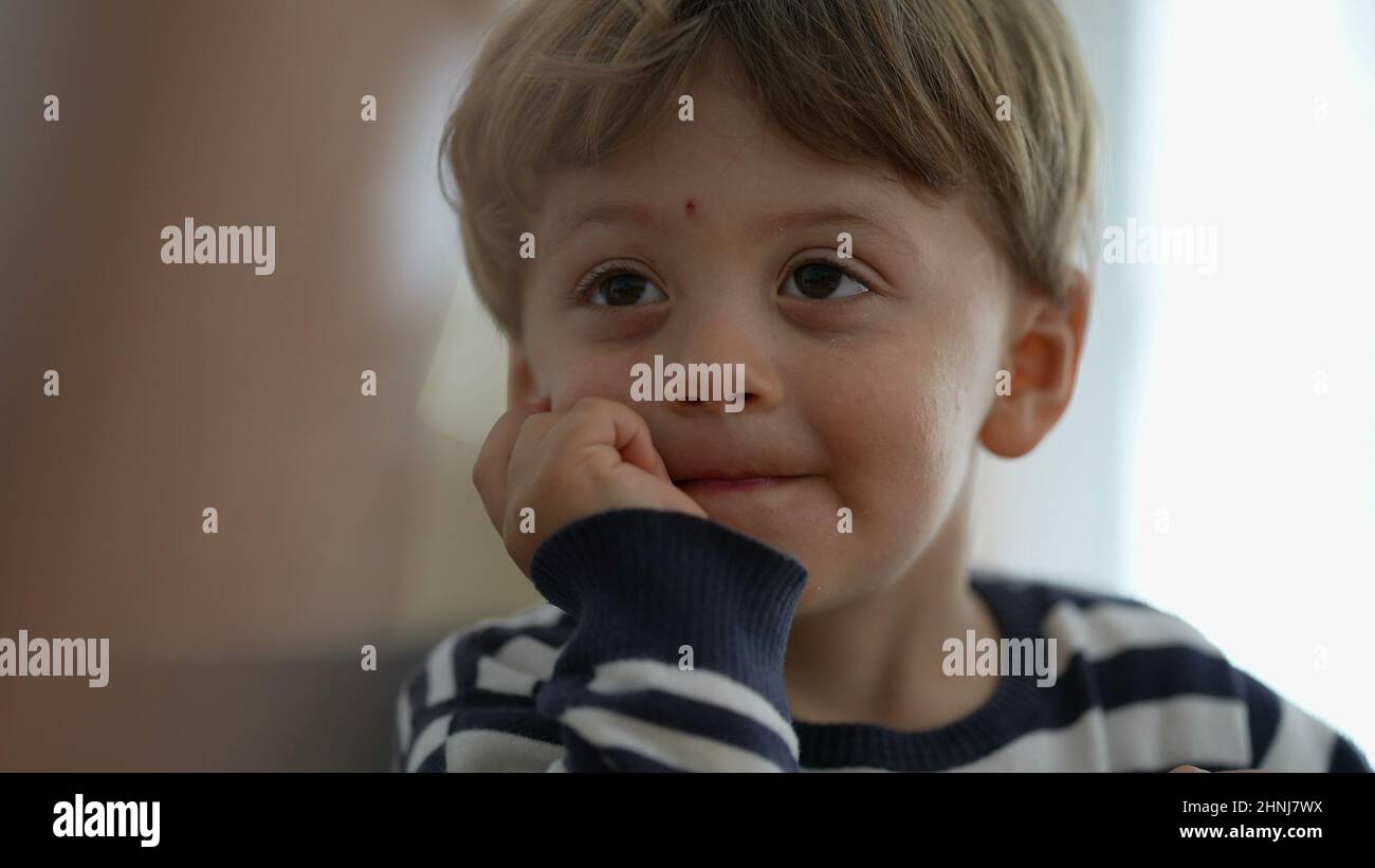 One pensive little boy thoughtful child portrait face Stock Photo - Alamy