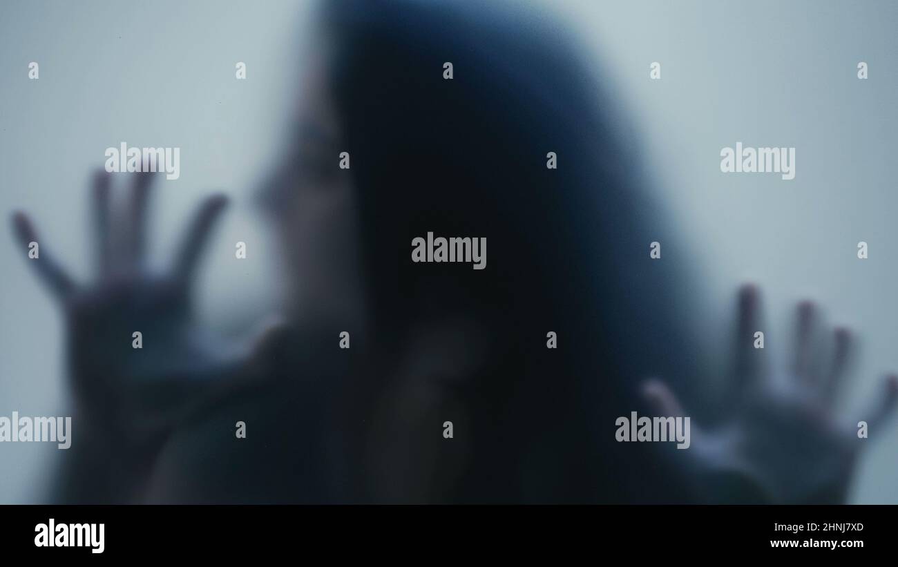 Person in pain behind glass woman suffering from depression concept ...