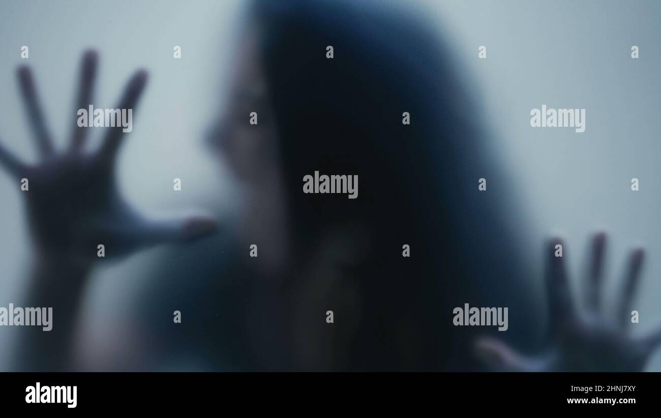 Person in pain behind glass woman suffering from depression concept ...