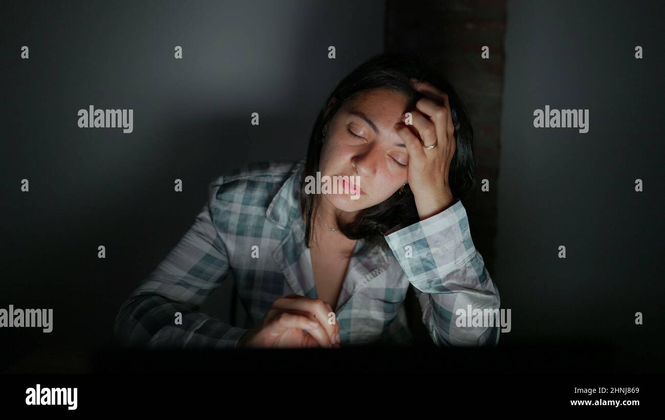 Tired woman in front of computer screen at night alone Stock Photo - Alamy