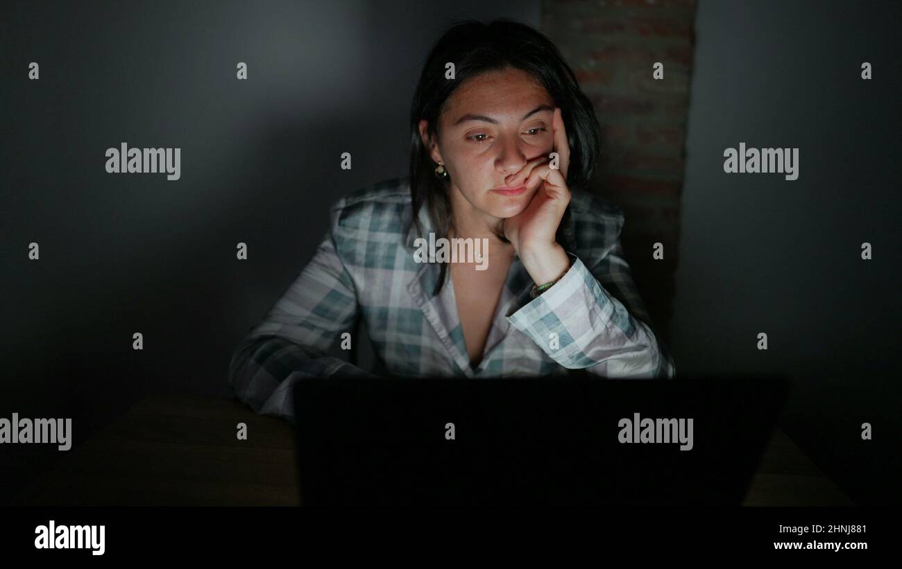 Tired woman in front of computer screen at night alone Stock Photo - Alamy