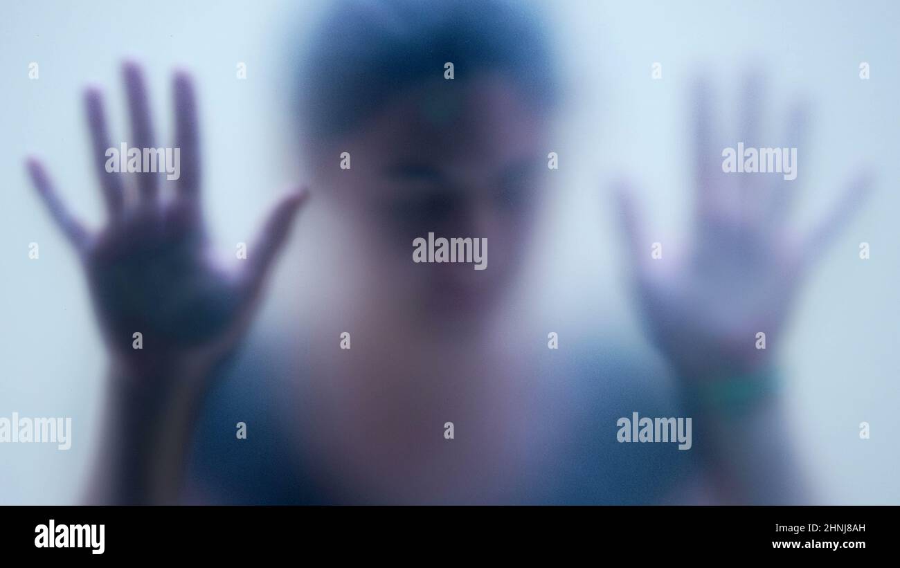 Woman behind matte glass blurry hand and body depression concept Stock ...