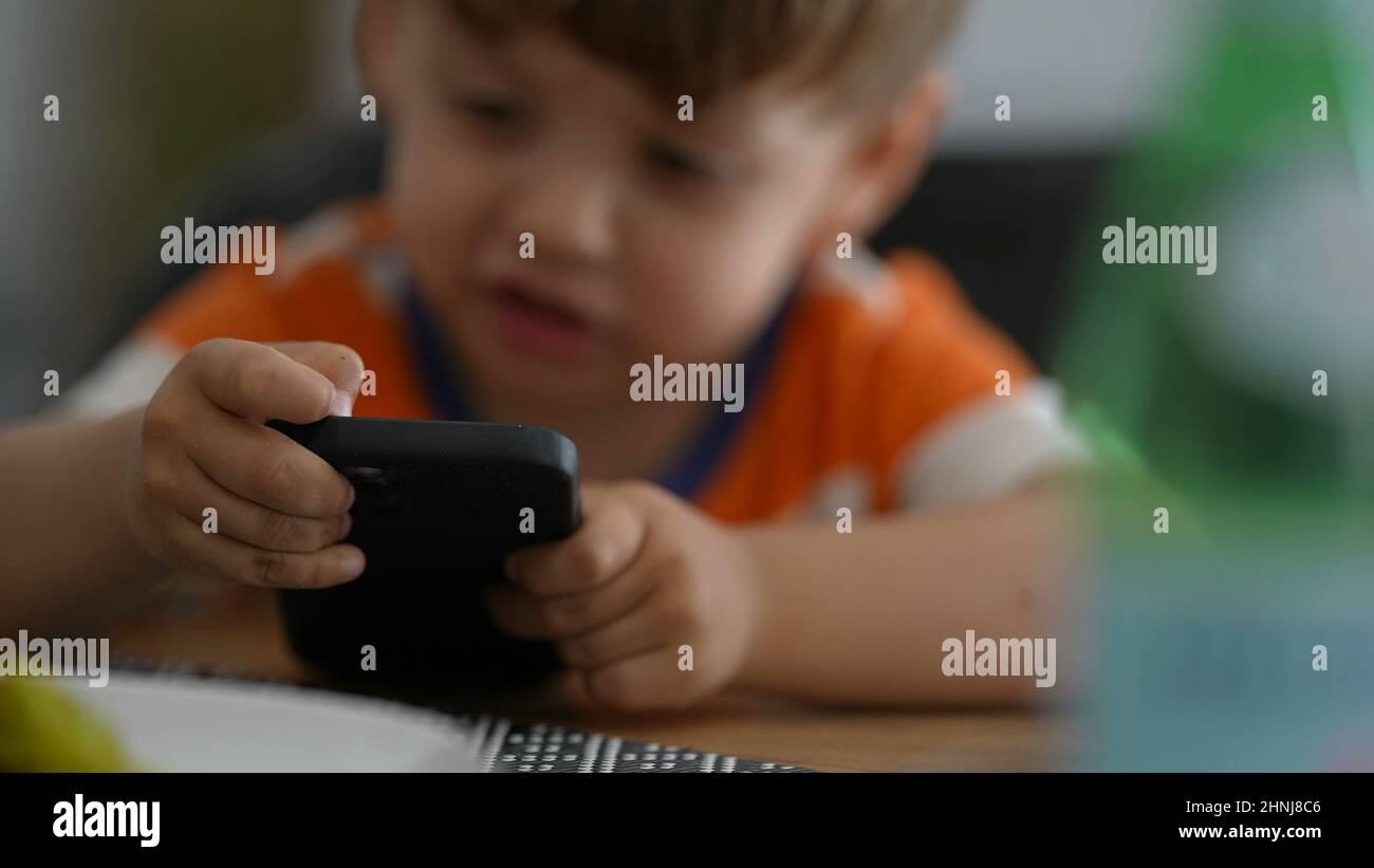 Upset little boy angry with technology child hitting phone screen being ...