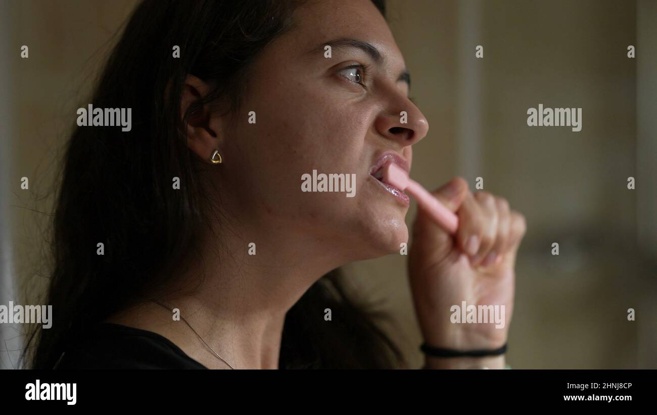 Woman brushing teeth before bed person night routine casual and real ...