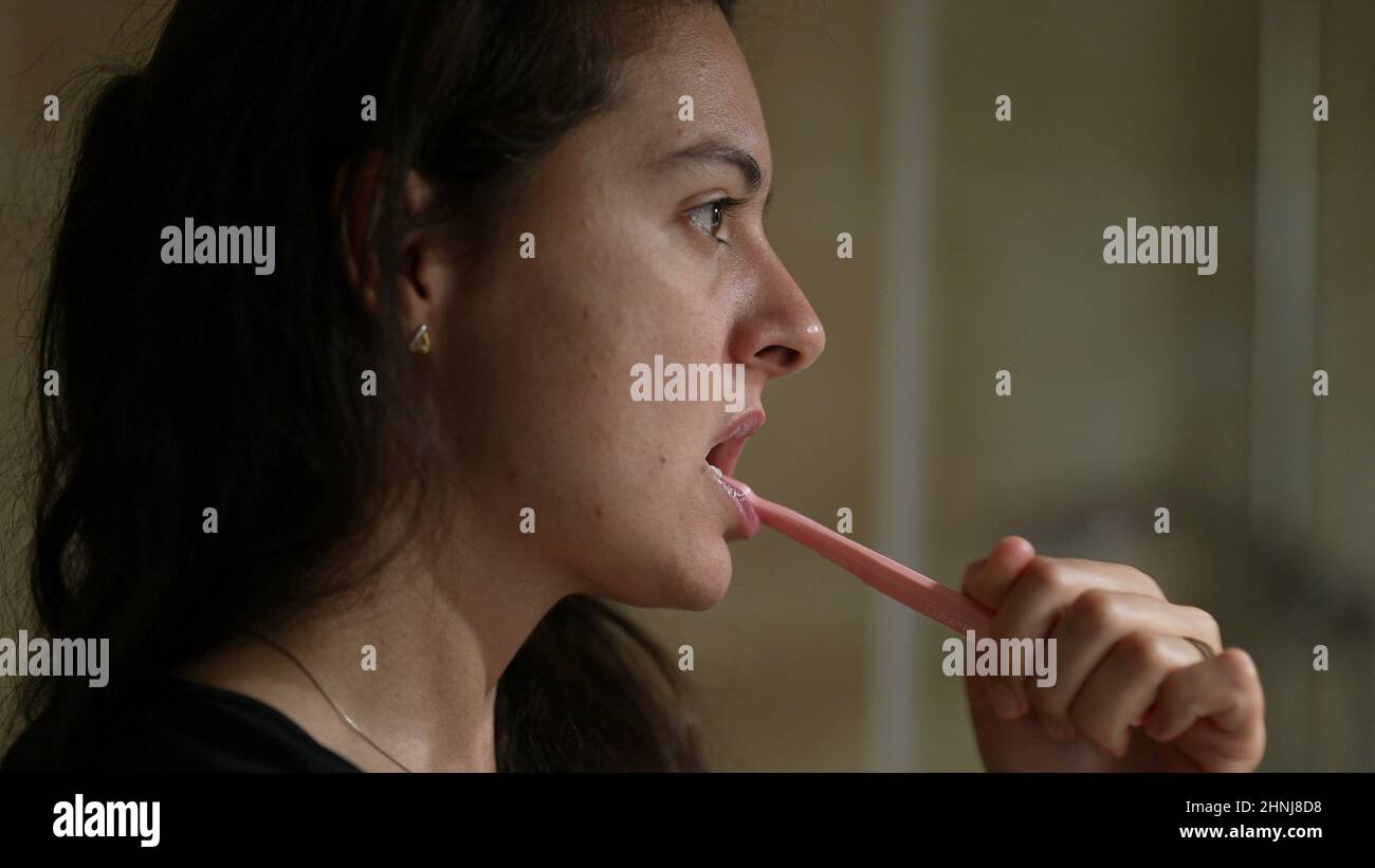 Woman brushing teeth before bed person night routine casual and real ...