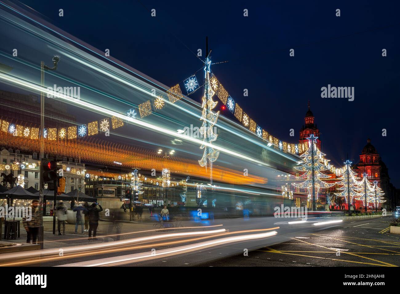 Bus races past Glasgow George Square decorated with Christmas lights ...