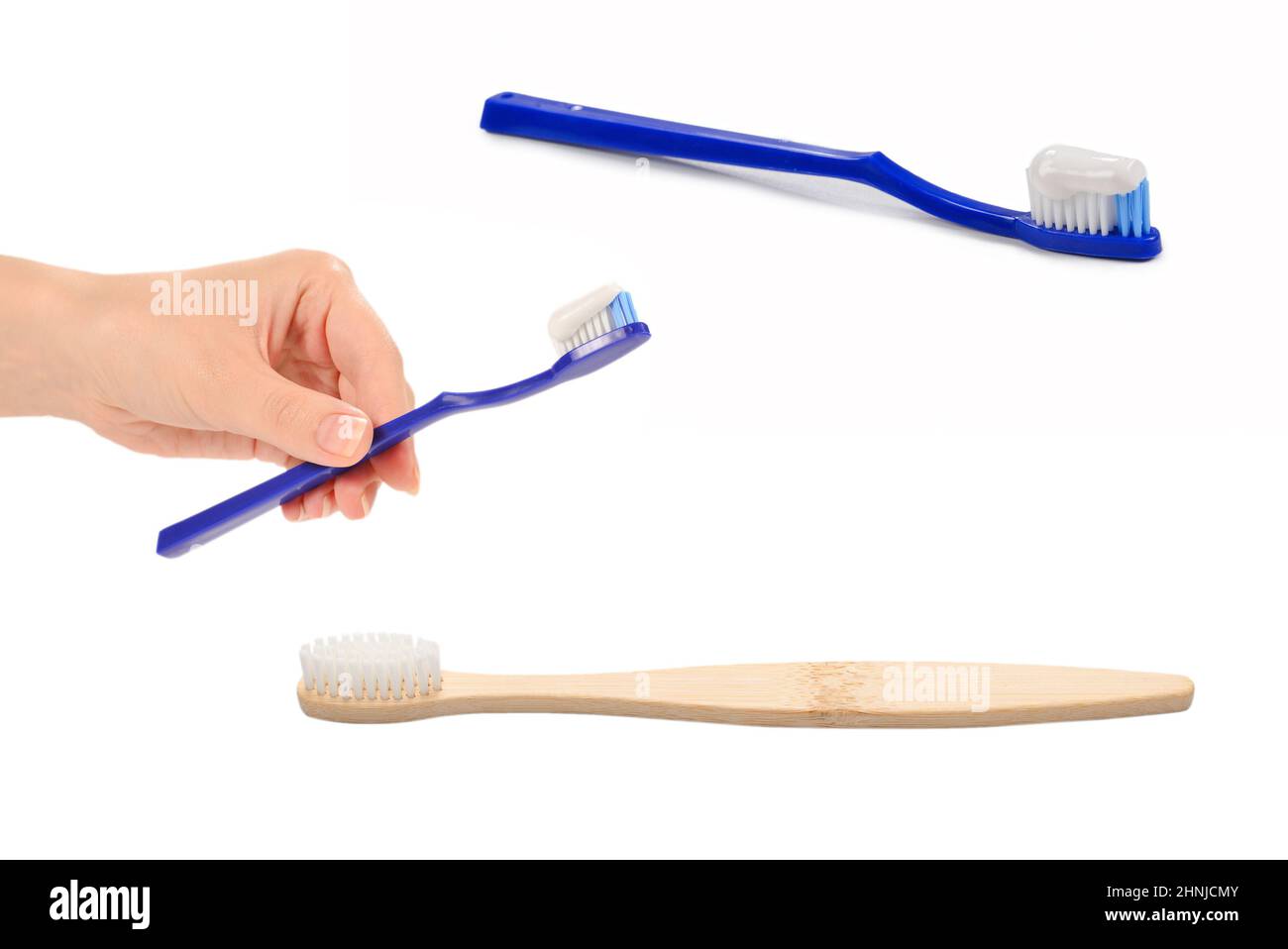 Blue toothbrush with toothpaste in her hand isolated on white ...