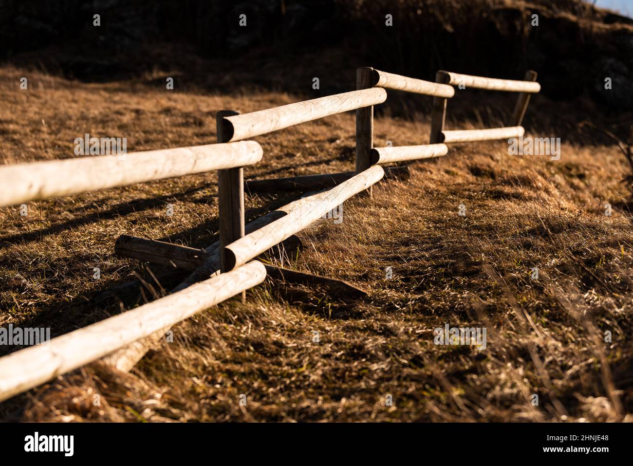 Fence made of wood on a grassy path in the German Swabian Alb Stock ...