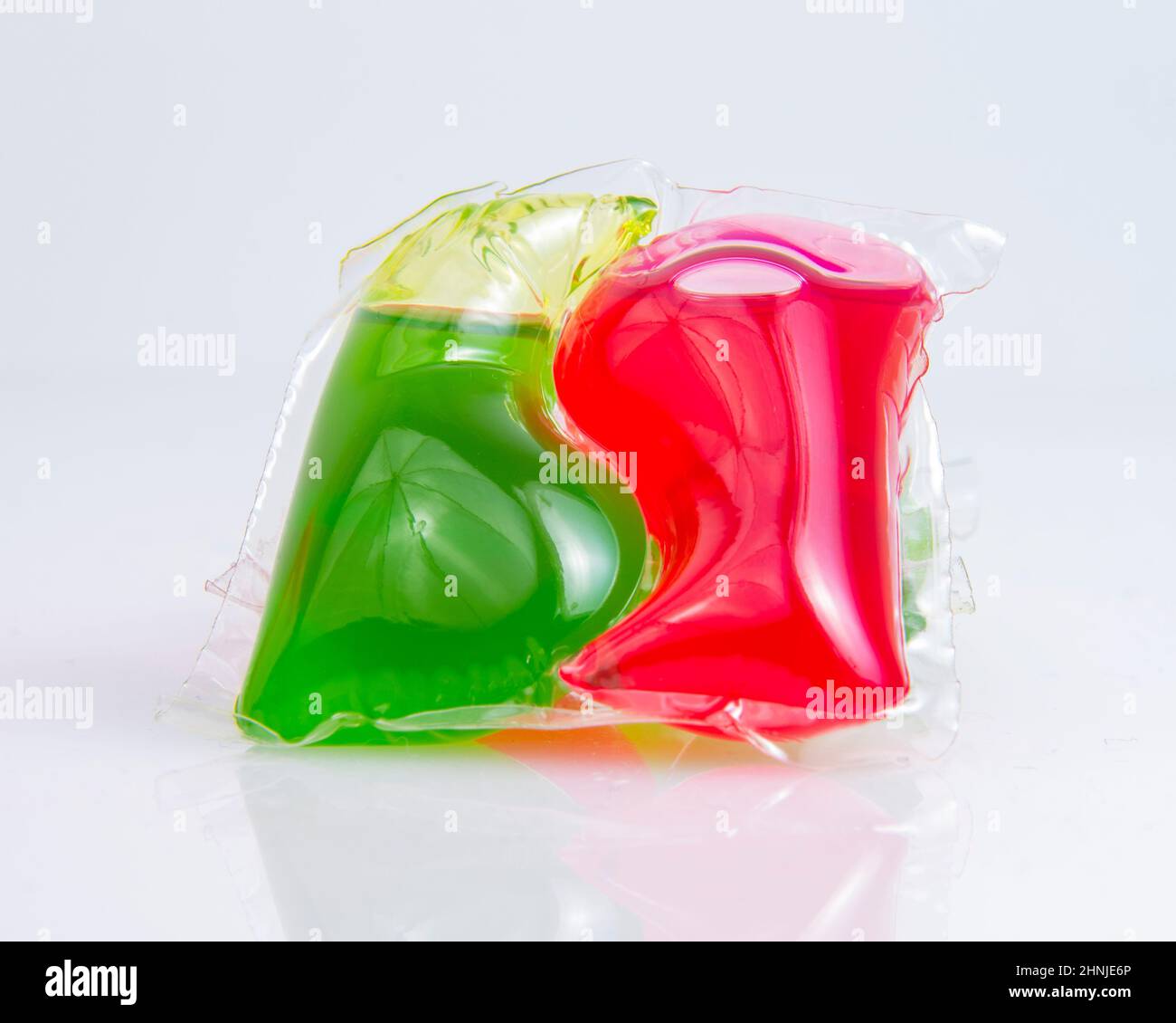 Red green capsule for cloth washing liquid powder isolated on the white ...
