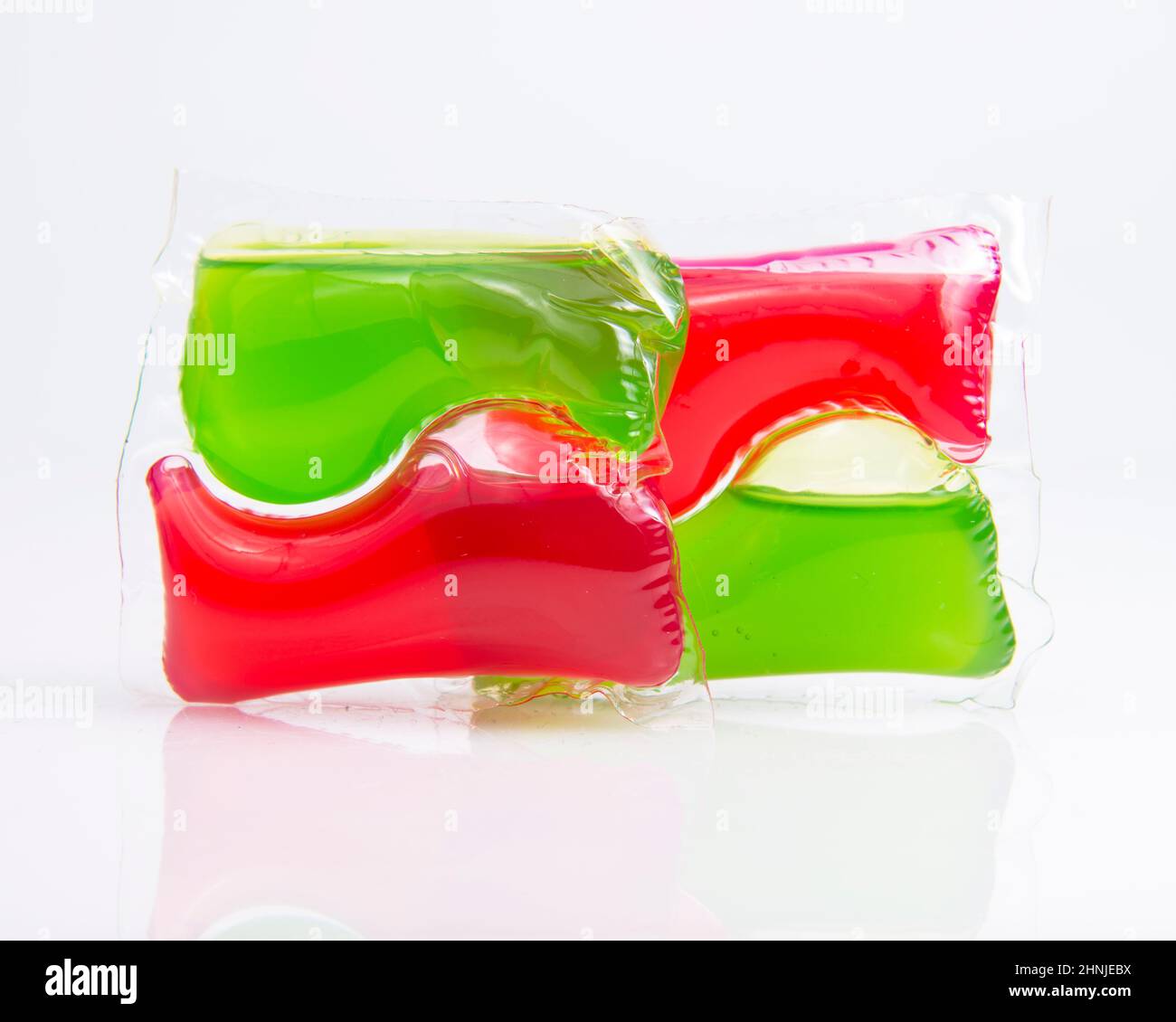 Red green capsule for cloth washing liquid powder isolated on the white ...